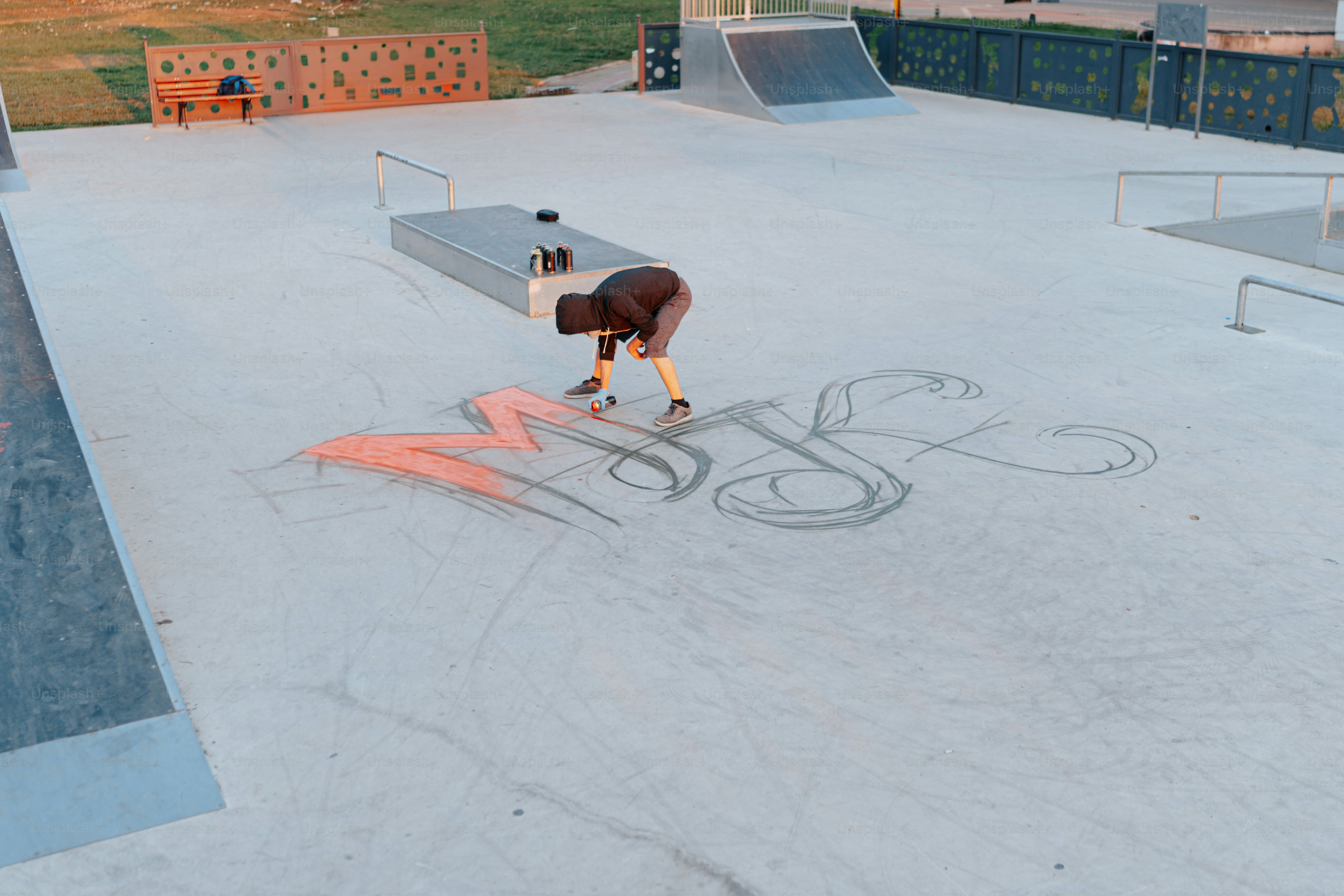 A man riding a skateboard down the side of a ramp photo – Making street ...