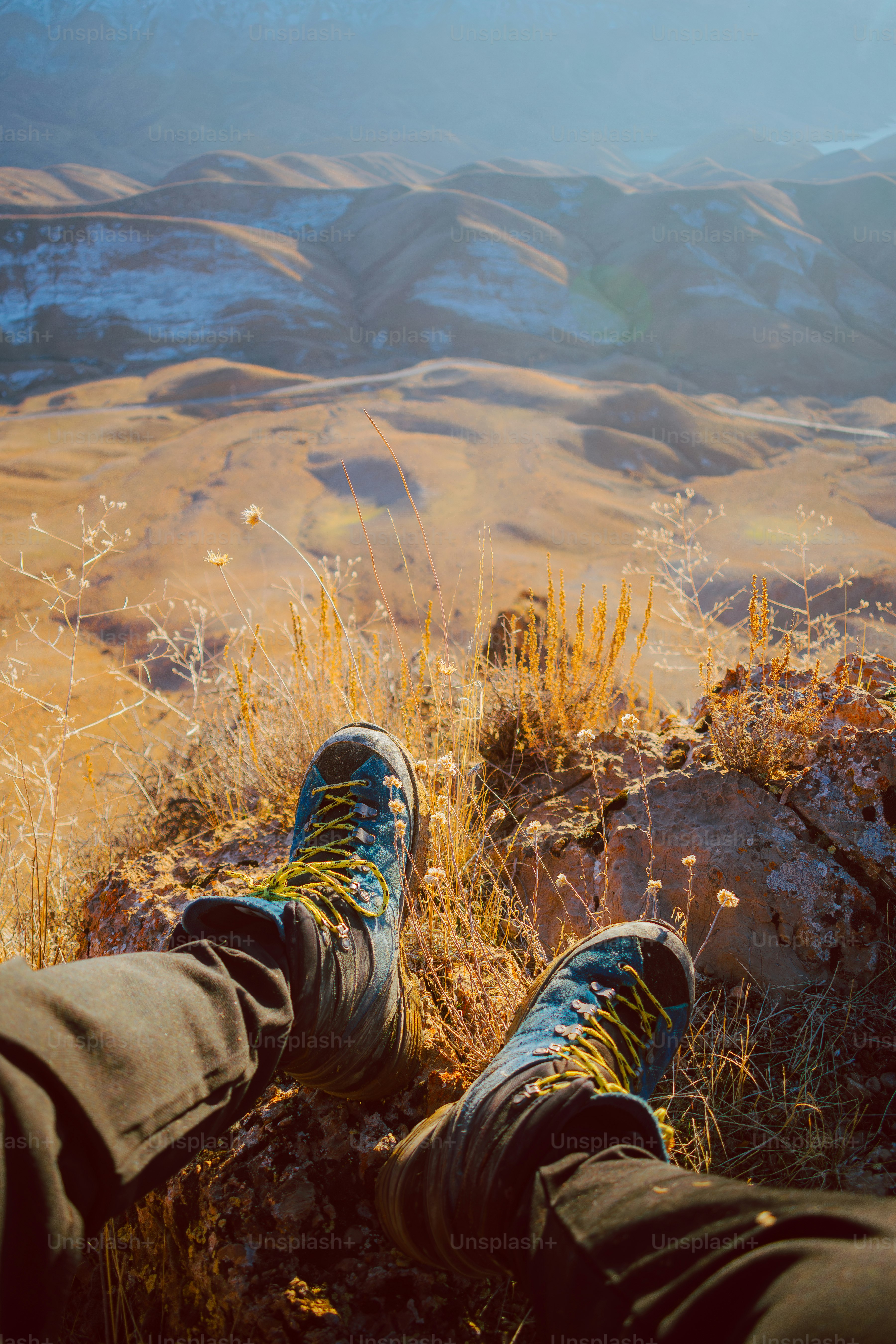 A pair of feet resting on top of a mountain photo – Iran Image on Unsplash