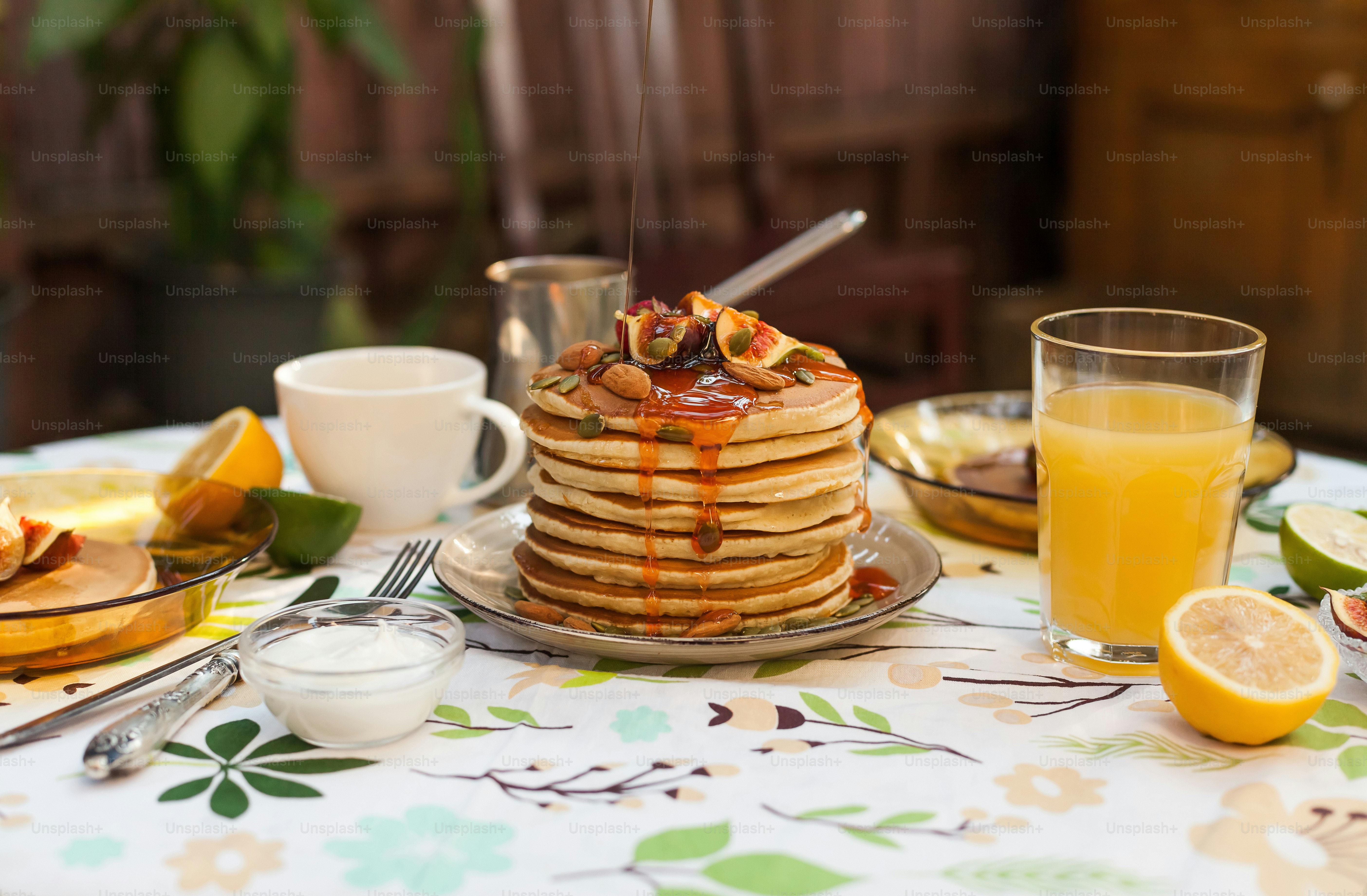 A stack of pancakes sitting on top of a table photo – Baked goods Image ...