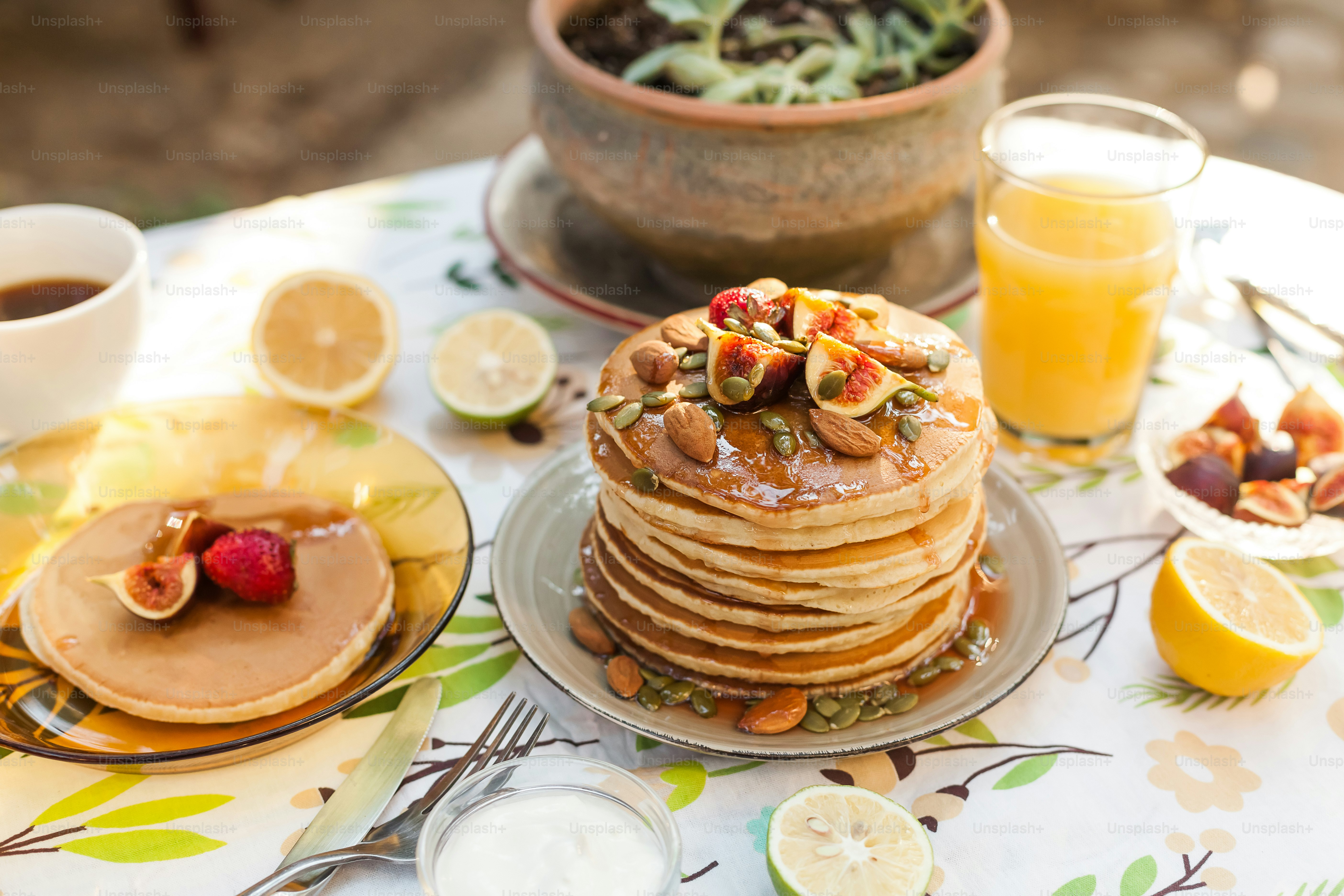 A stack of pancakes sitting on top of a table photo – Brunch Image on ...
