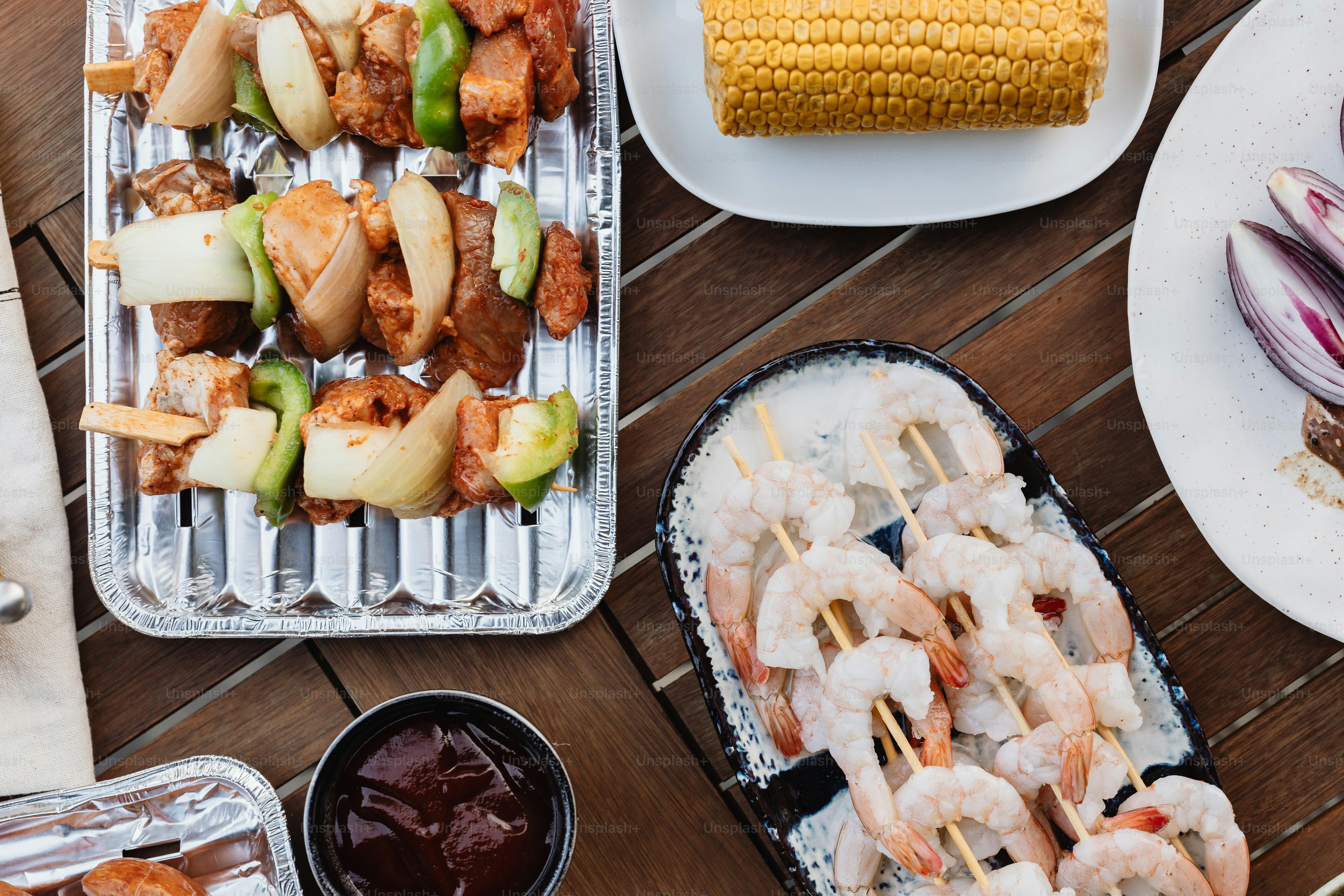 A person using a knife to cut up food on a grill photo – Grilling Image ...