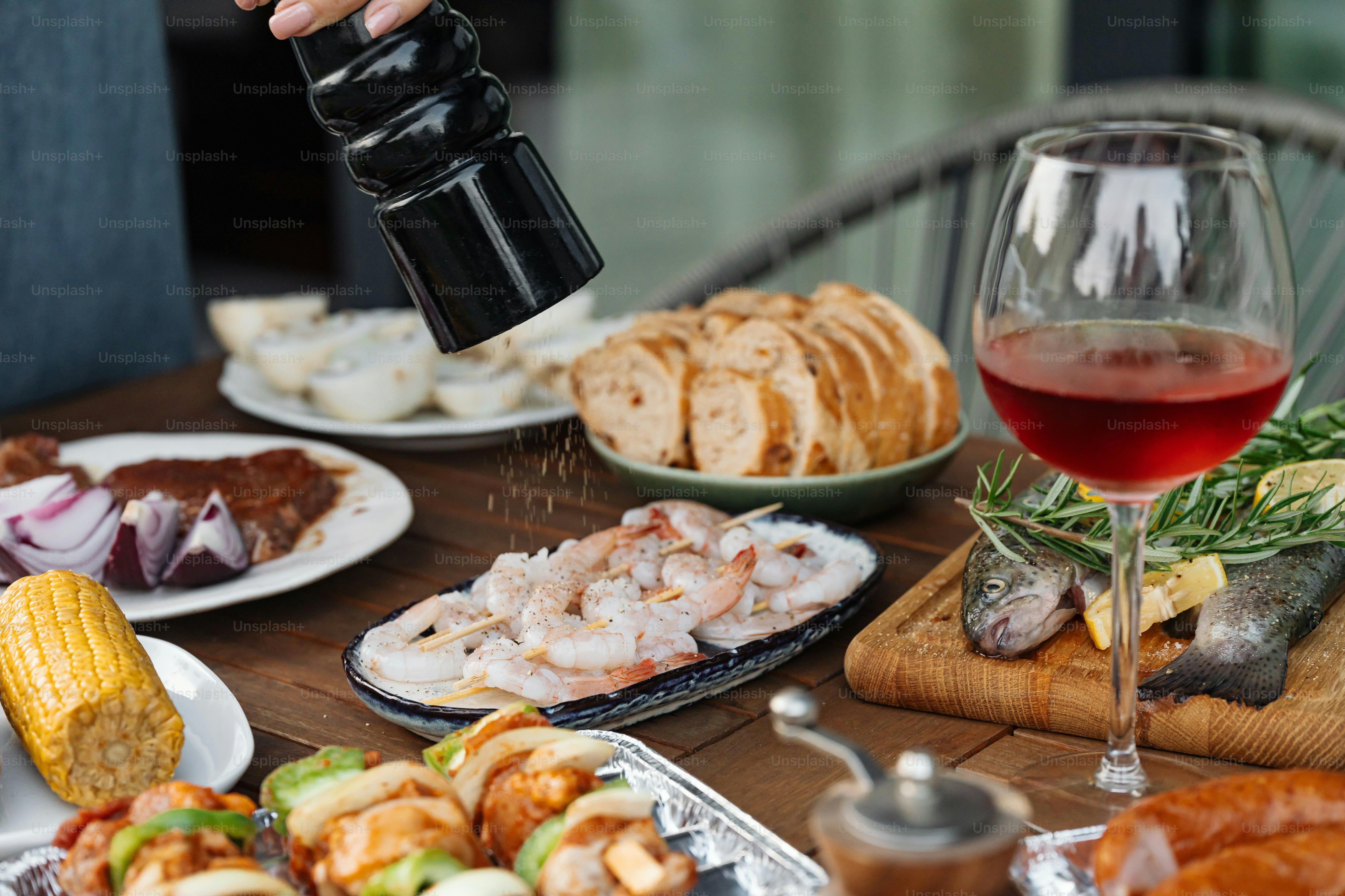 A person using a knife to cut up food on a grill photo – Bbq Image on ...