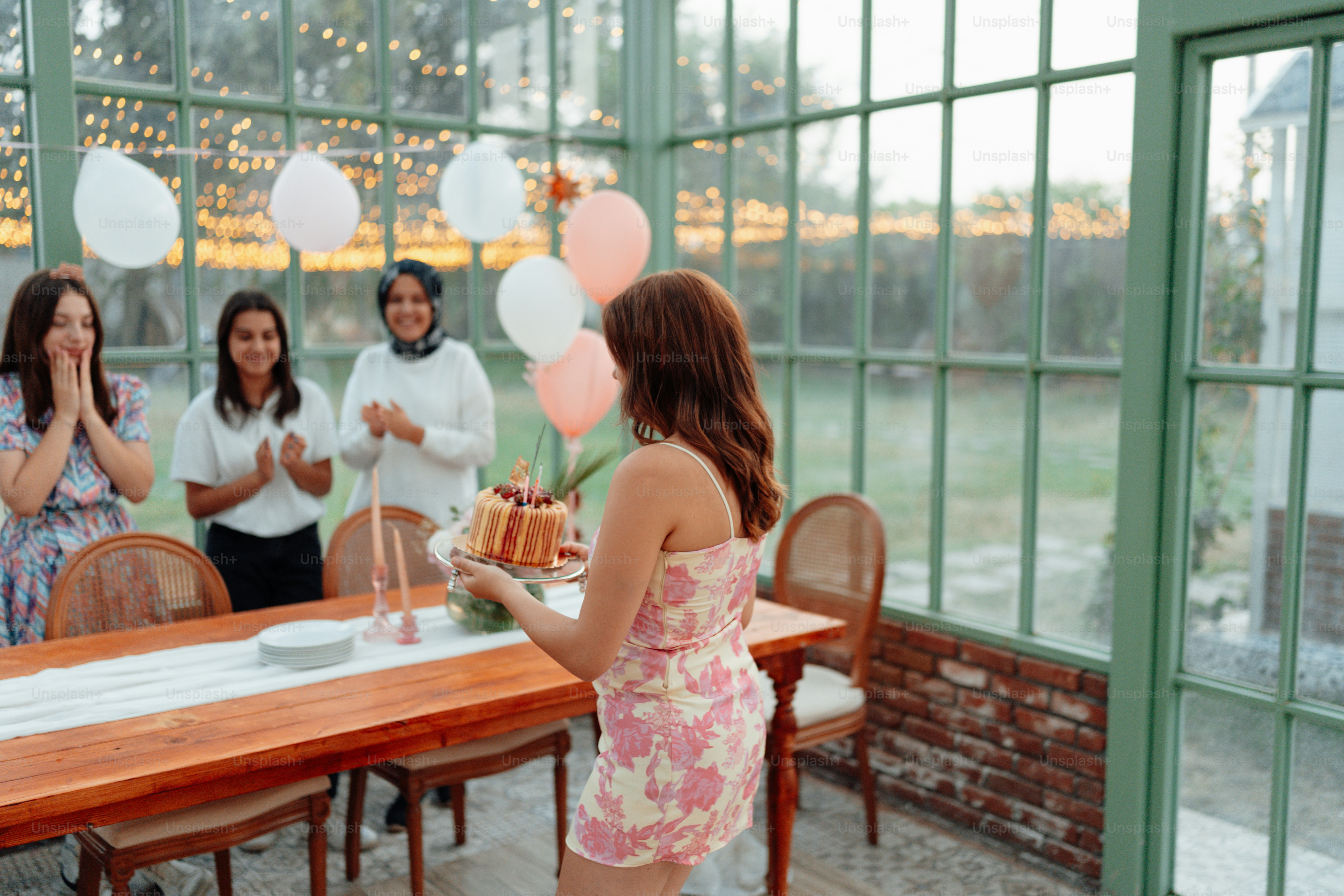 A group of women standing around a table with a cake photo – Birthday ...
