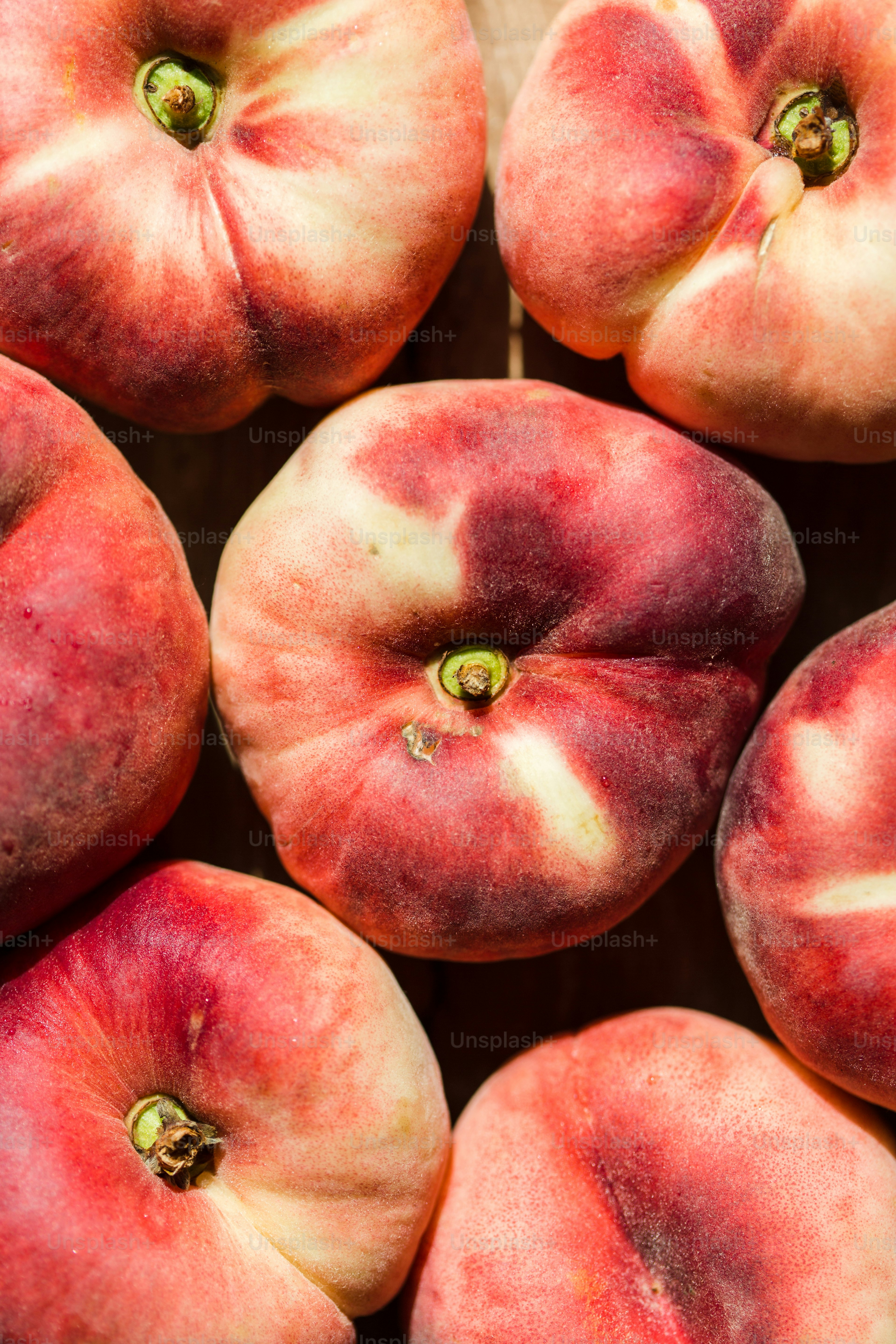 A pile of peaches sitting on top of each other photo – Peach Image on ...