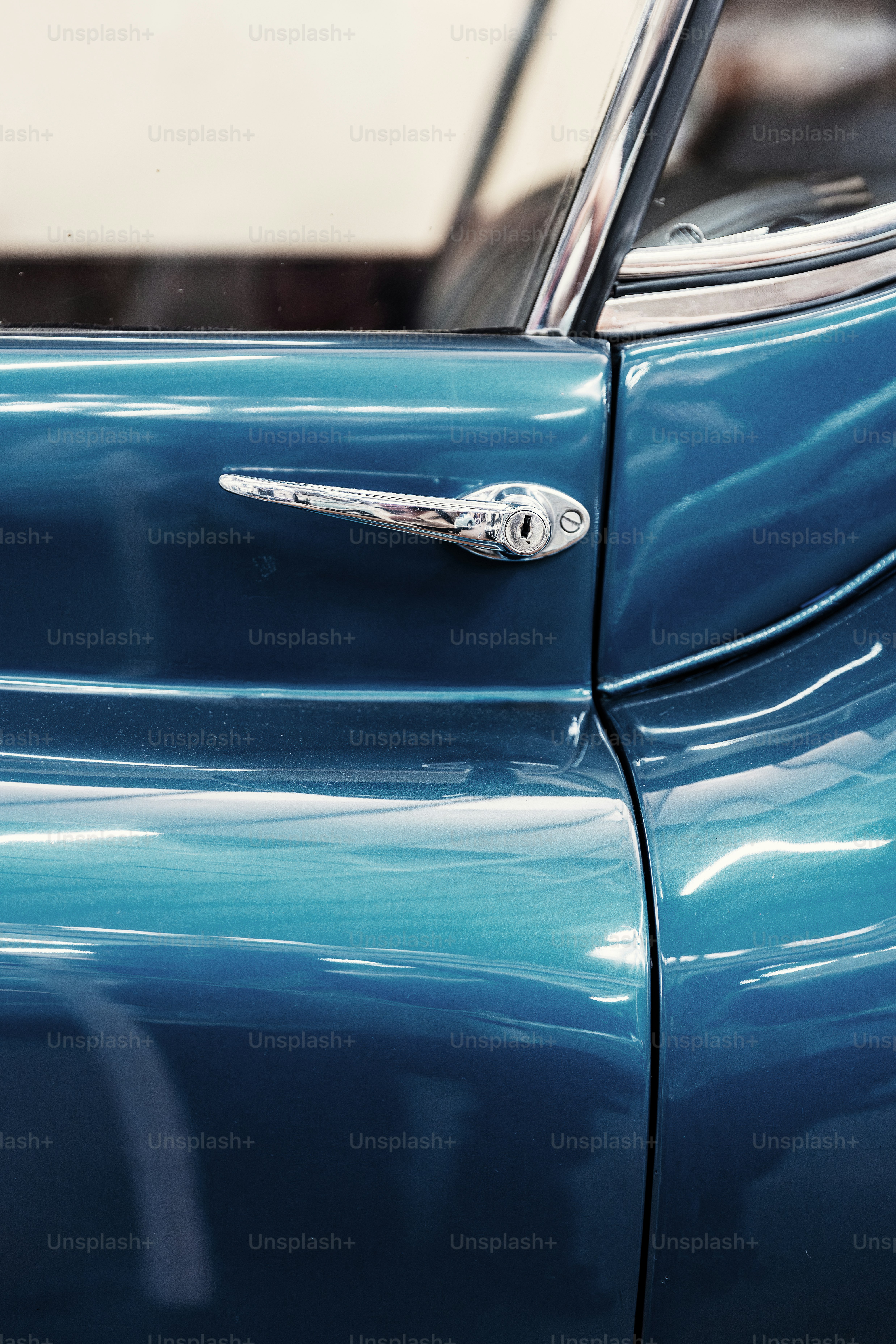 A close up of a blue car door handle photo – Automobile Image on Unsplash