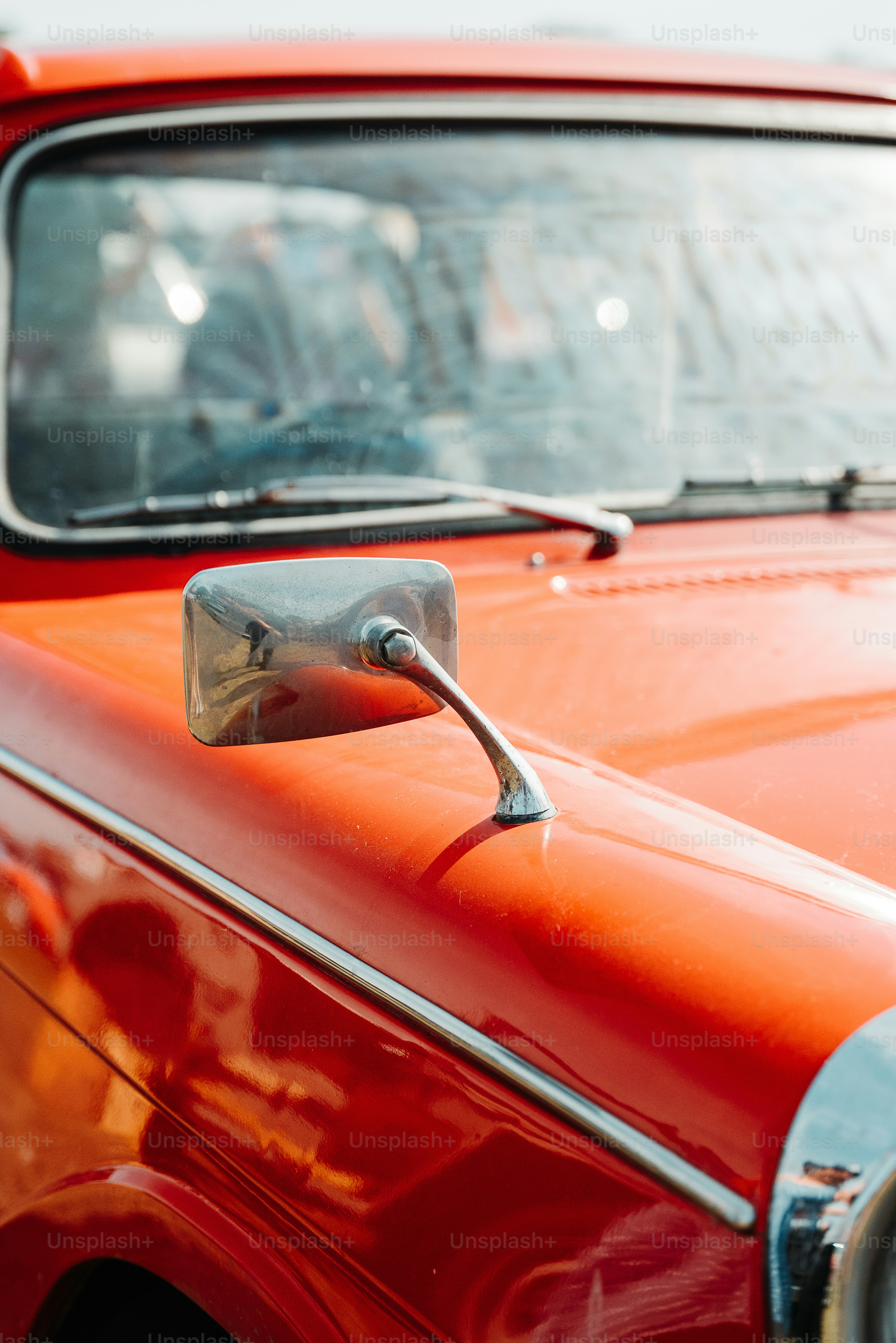 A close up of a bright red car headlight photo – Car Image on Unsplash