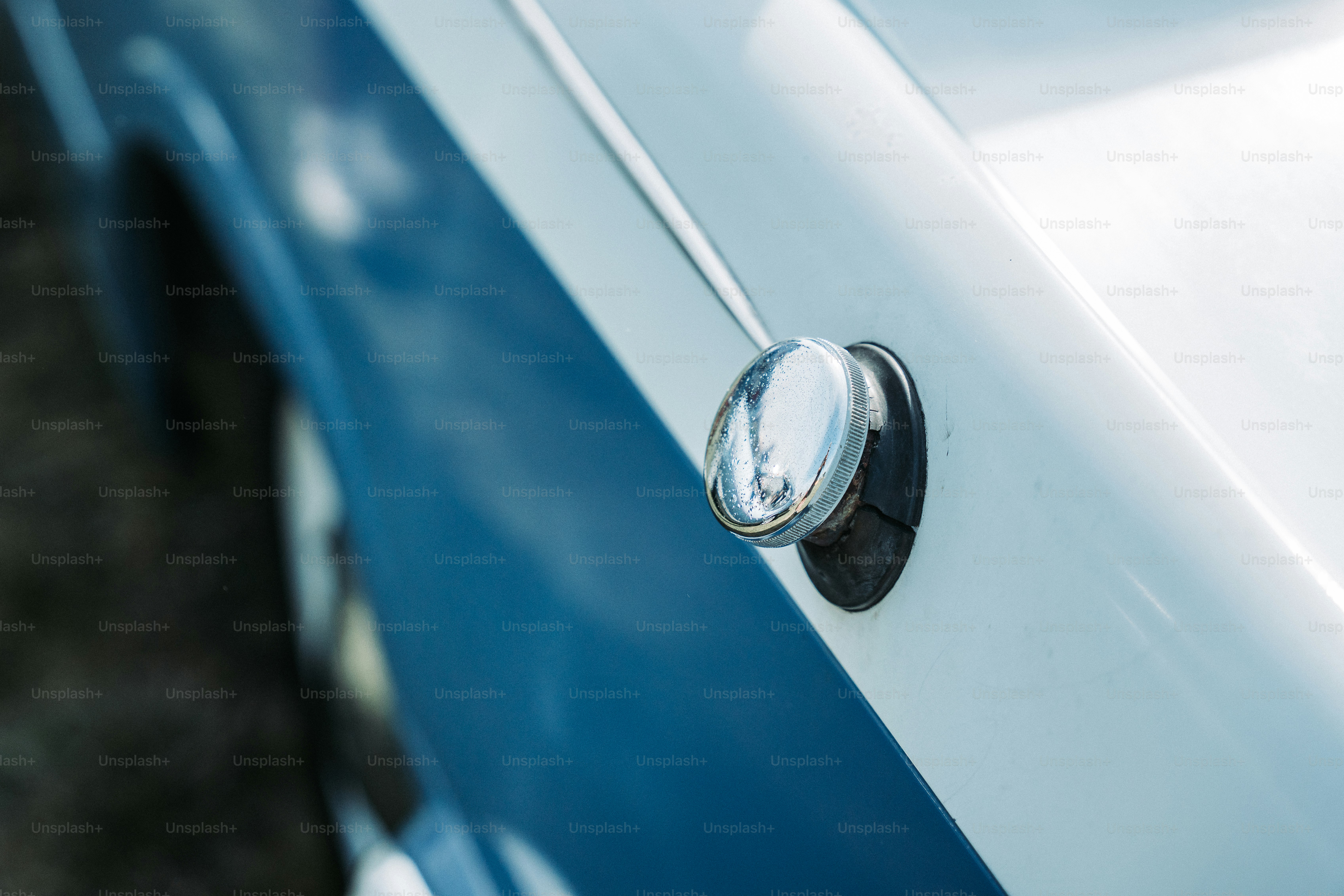 A close up of a blue and white car door handle photo – Car Image on ...