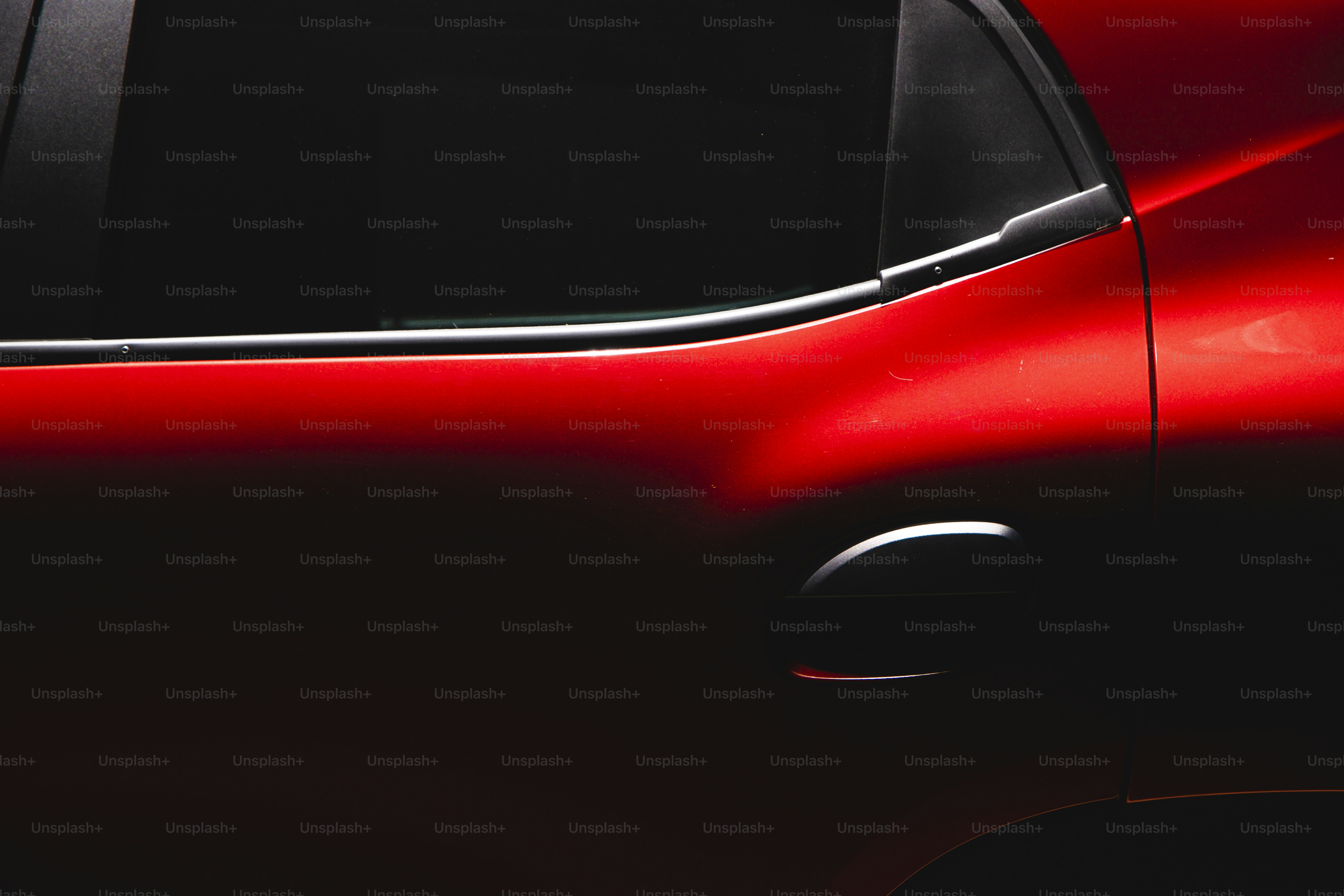 A close up of the side of a red car photo – Car Image on Unsplash