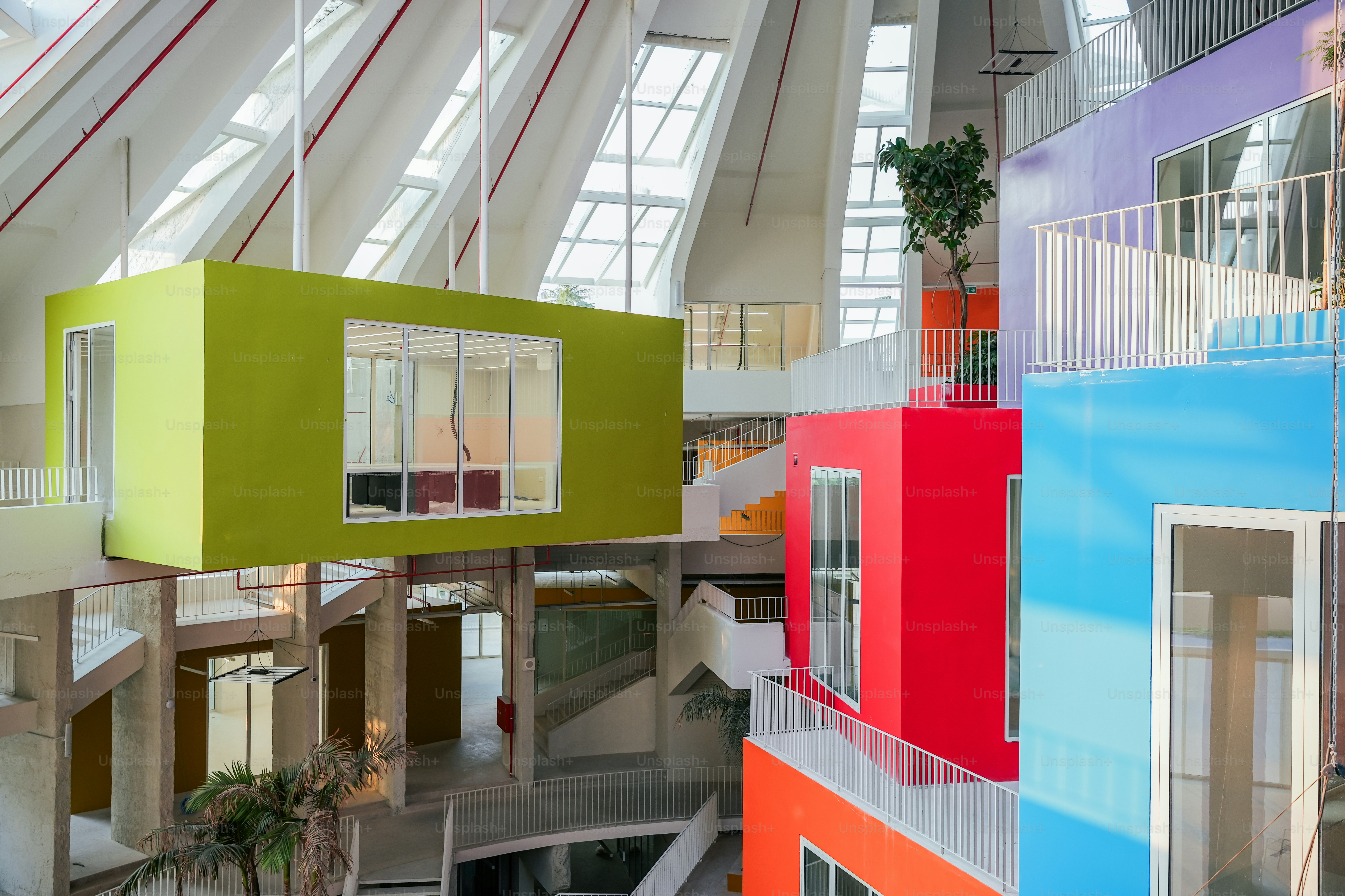 A multicolored building with multiple levels of windows and balconies ...