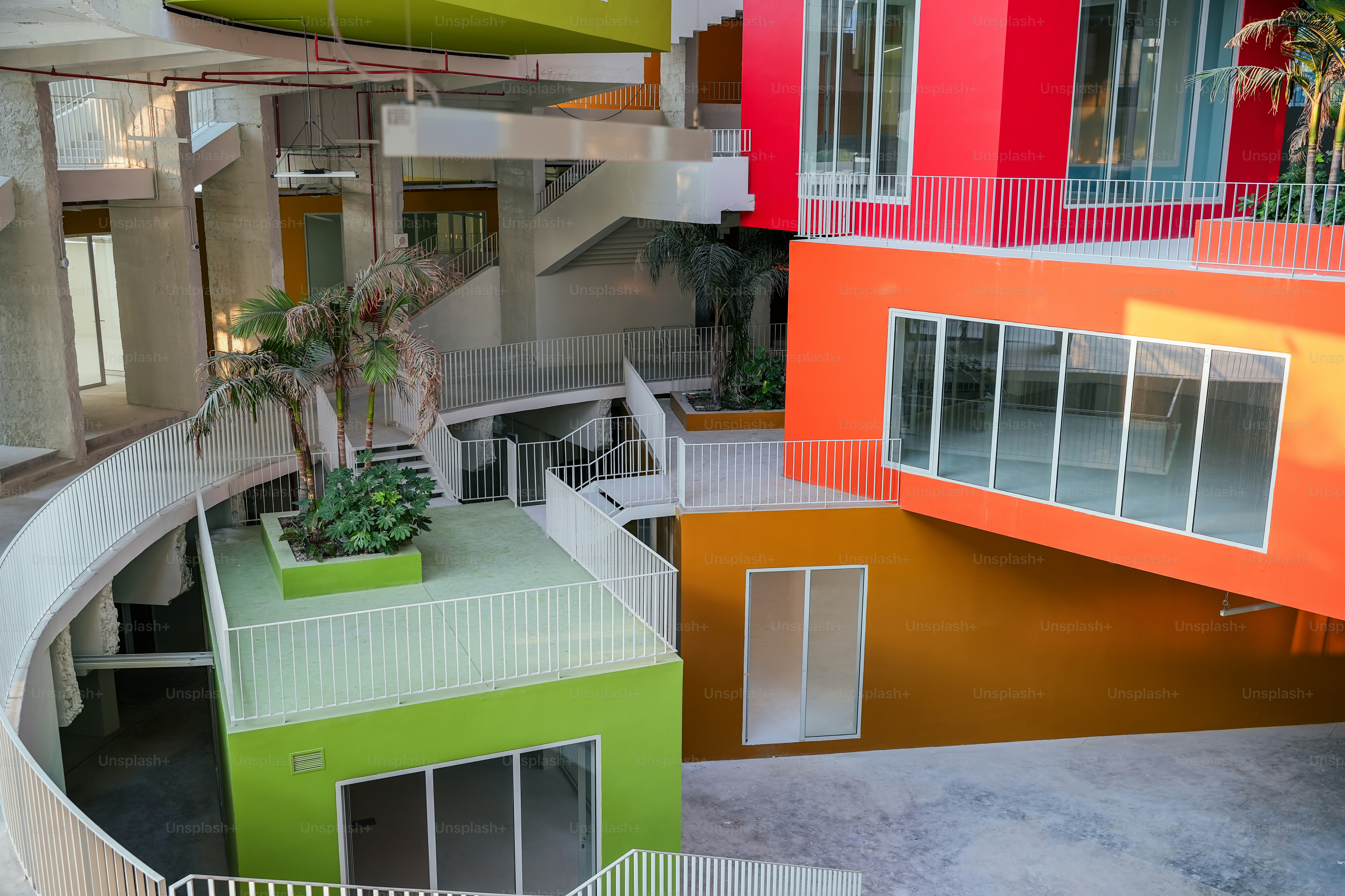 A multicolored building with multiple levels of windows and balconies ...