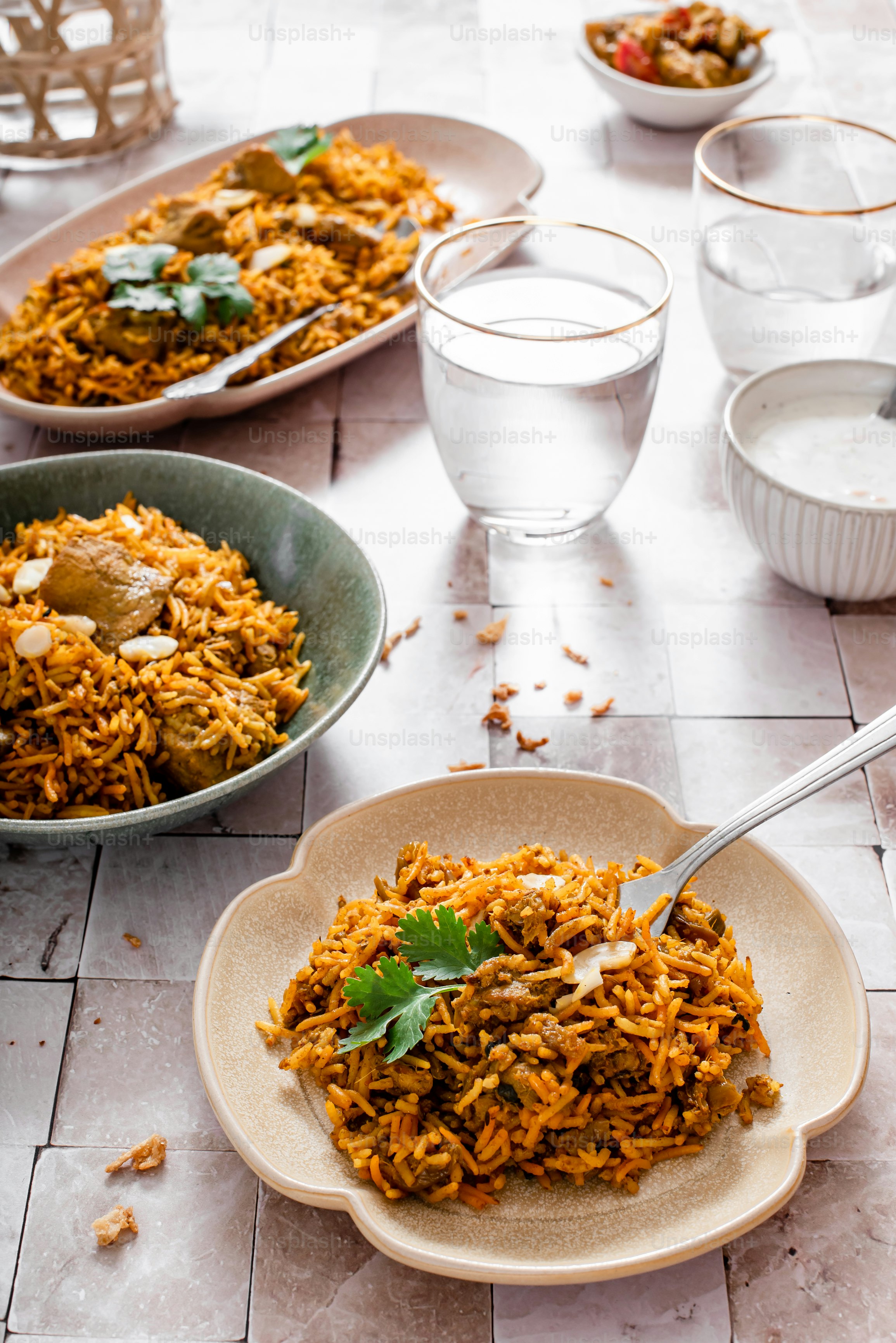 A bowl filled with rice and meat on top of a table photo – Indian food ...