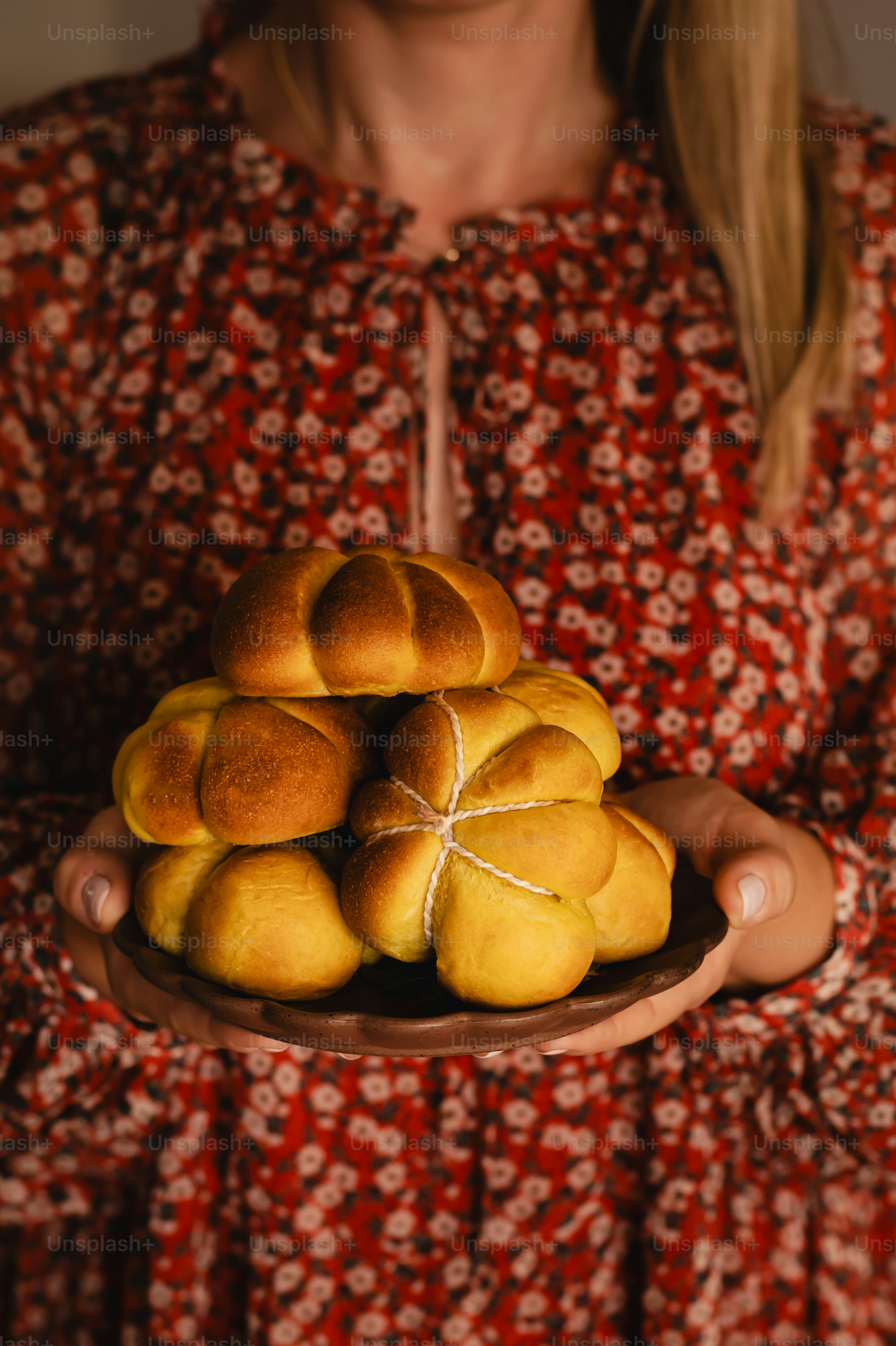 A woman in a red dress holding a plate of bread photo – Autumn Image on ...