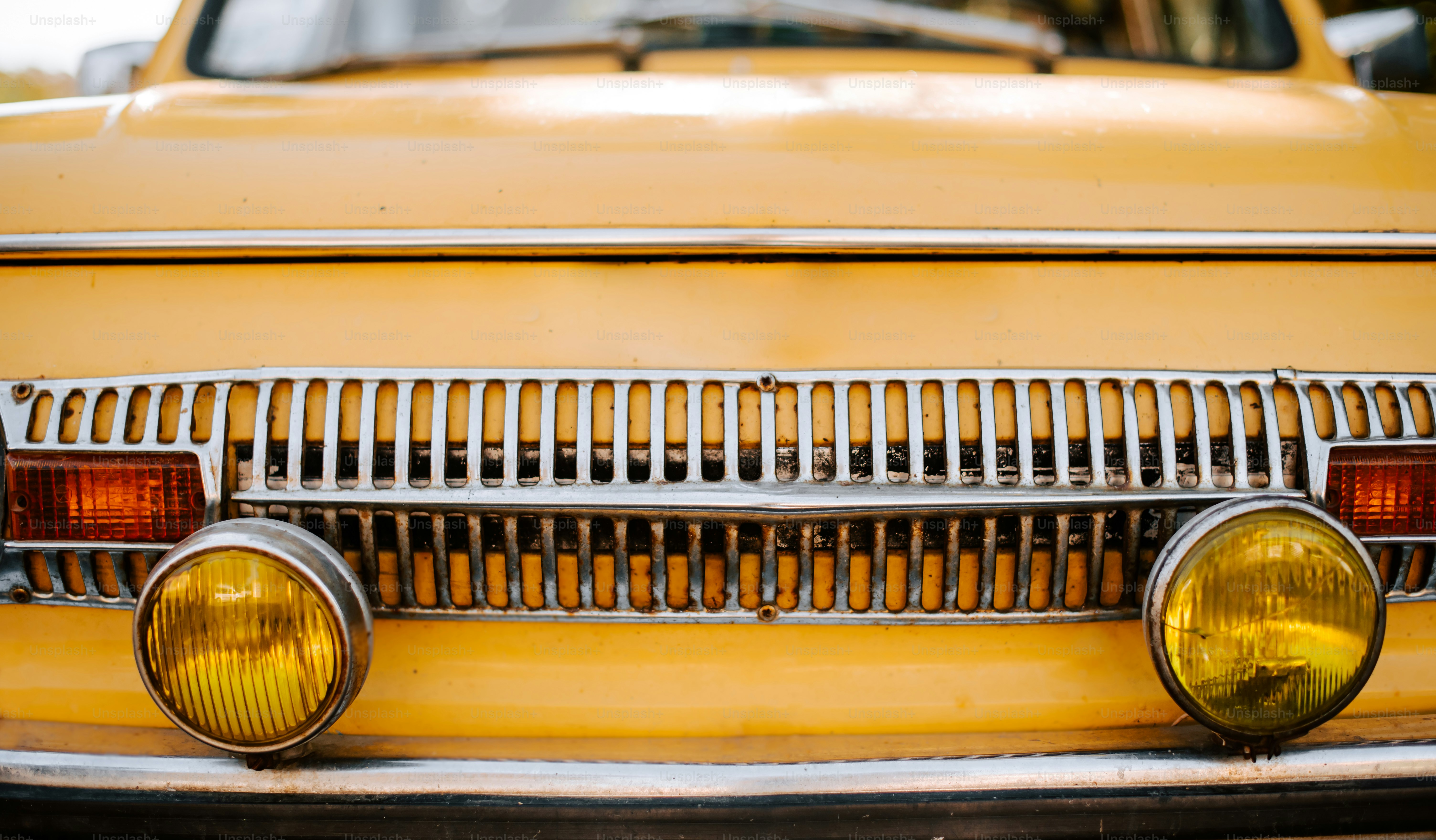 A close up of the front of a yellow car photo – Car Image on Unsplash