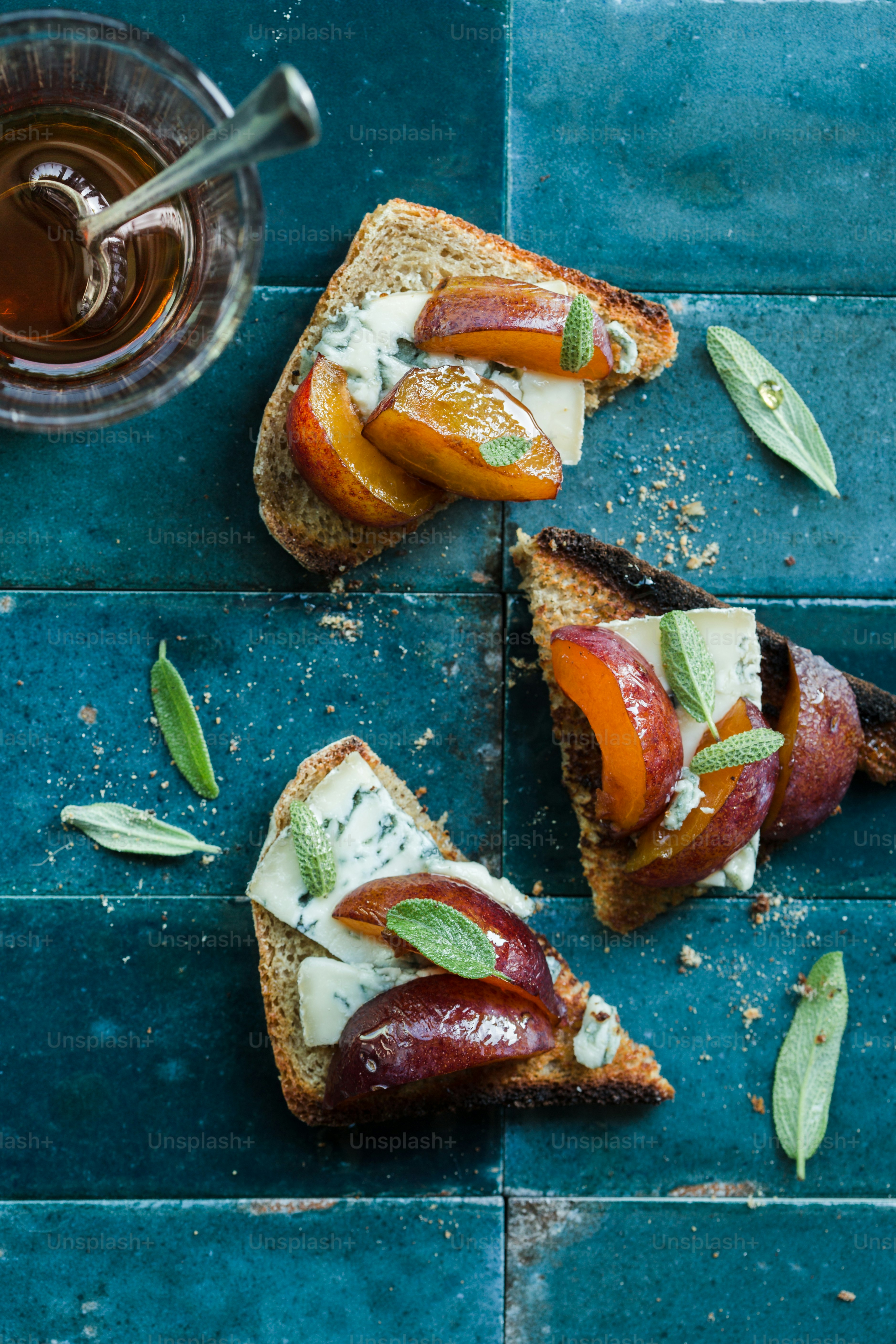Three slices of toast with fruit and cheese on them photo – Toast Image ...