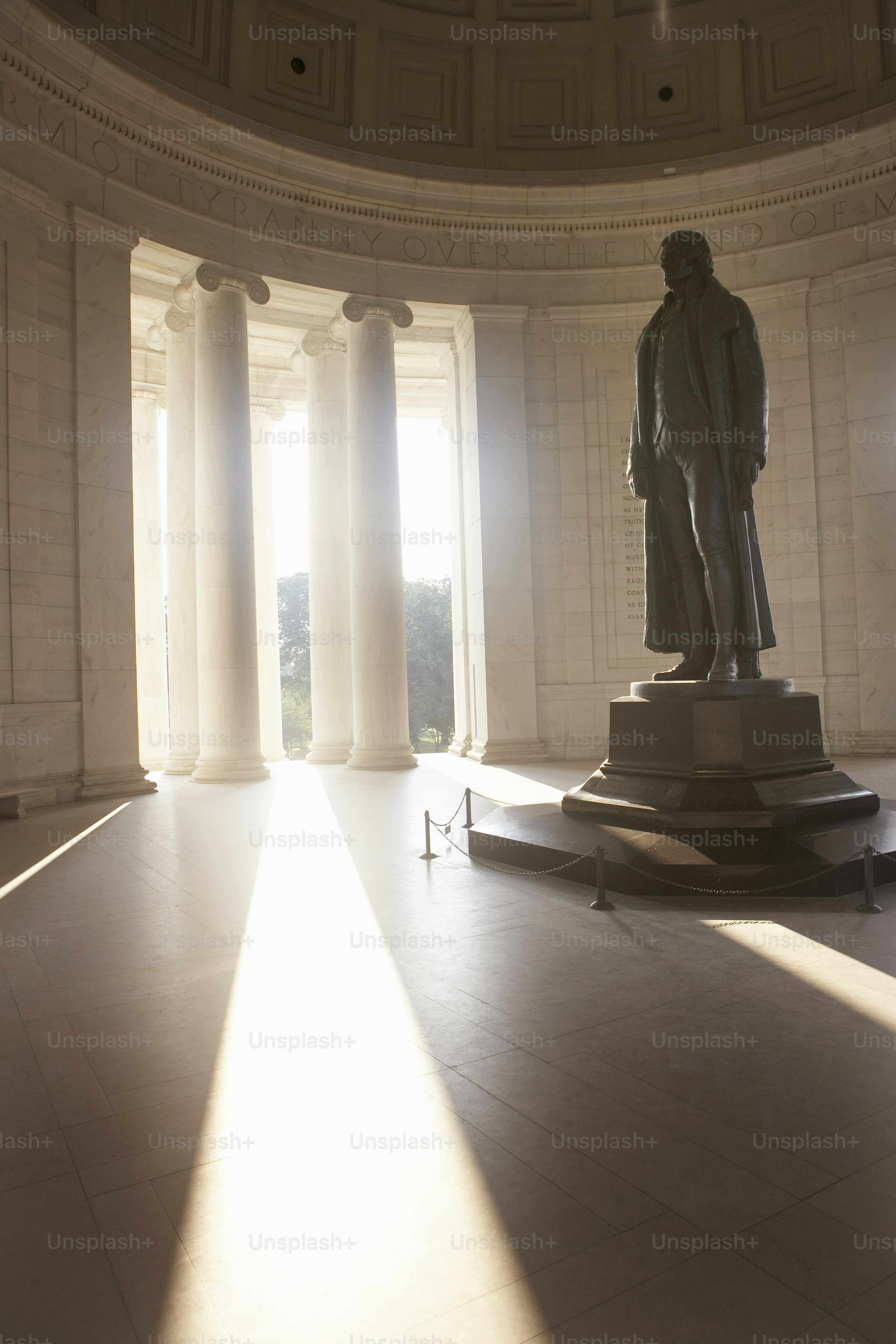 A statue of a man in a room with columns photo – Architecture Image on ...