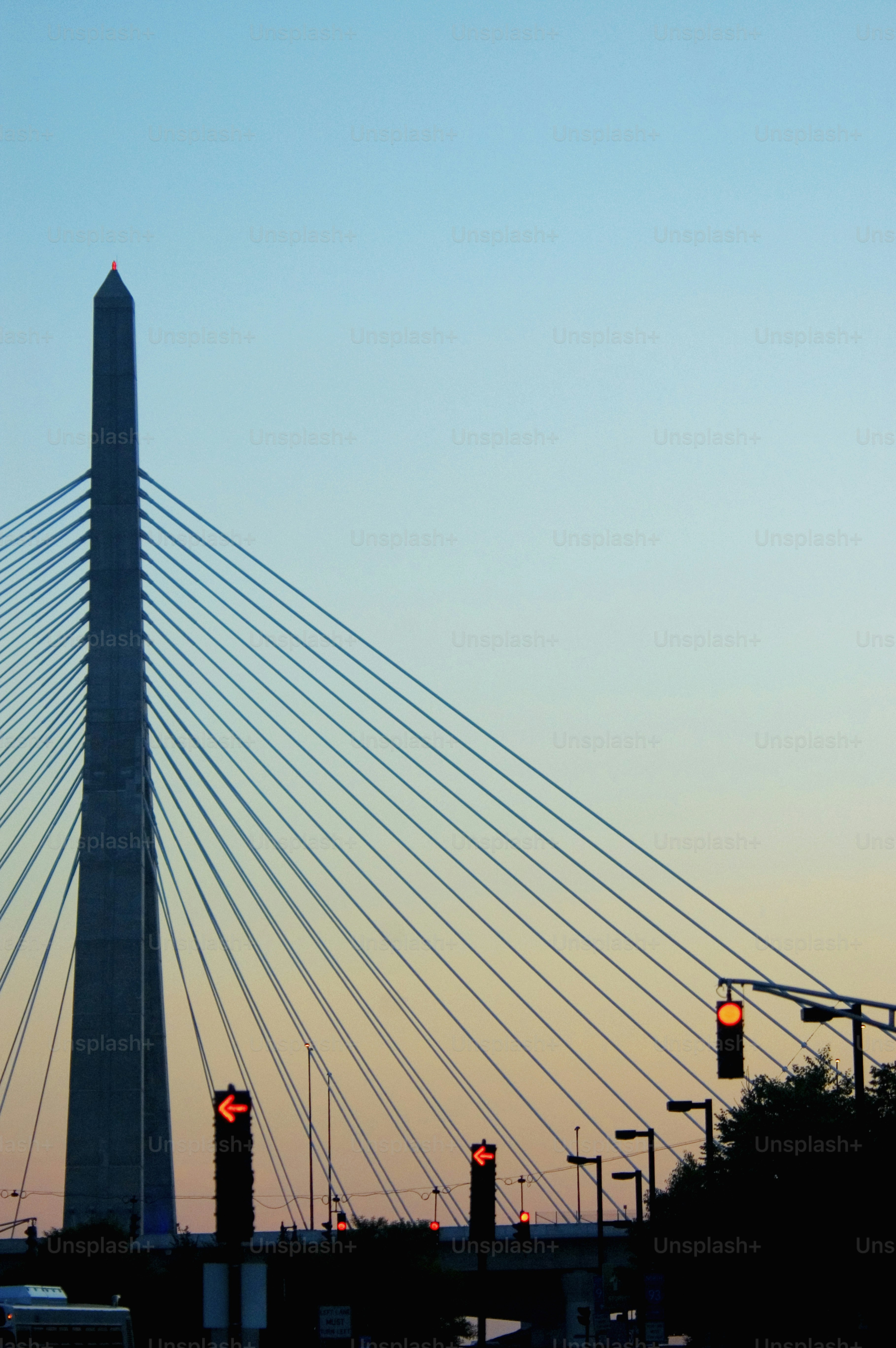 A very tall bridge with a very tall building in the background photo ...