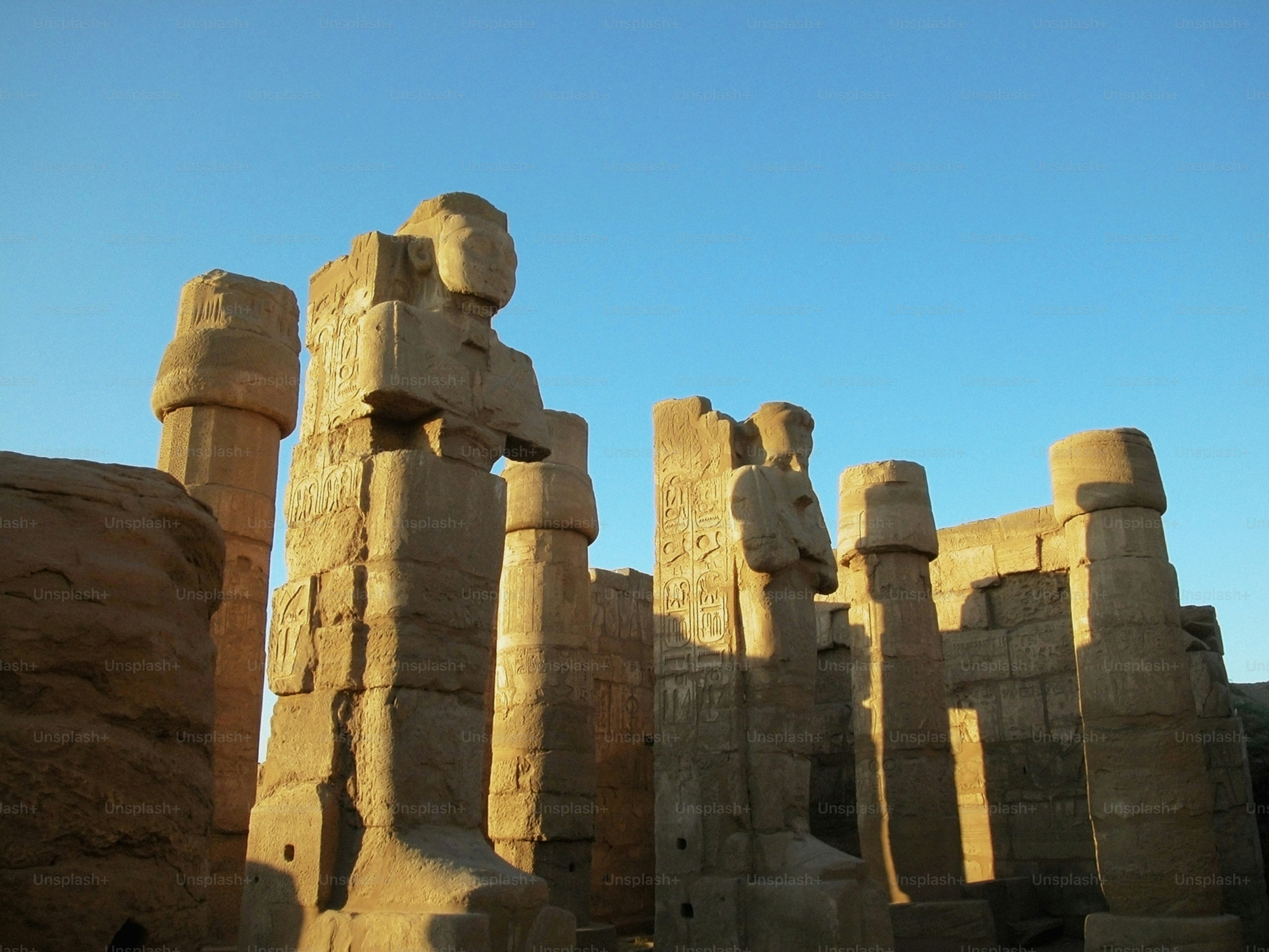 A group of large stone pillars sitting next to each other photo – Built ...