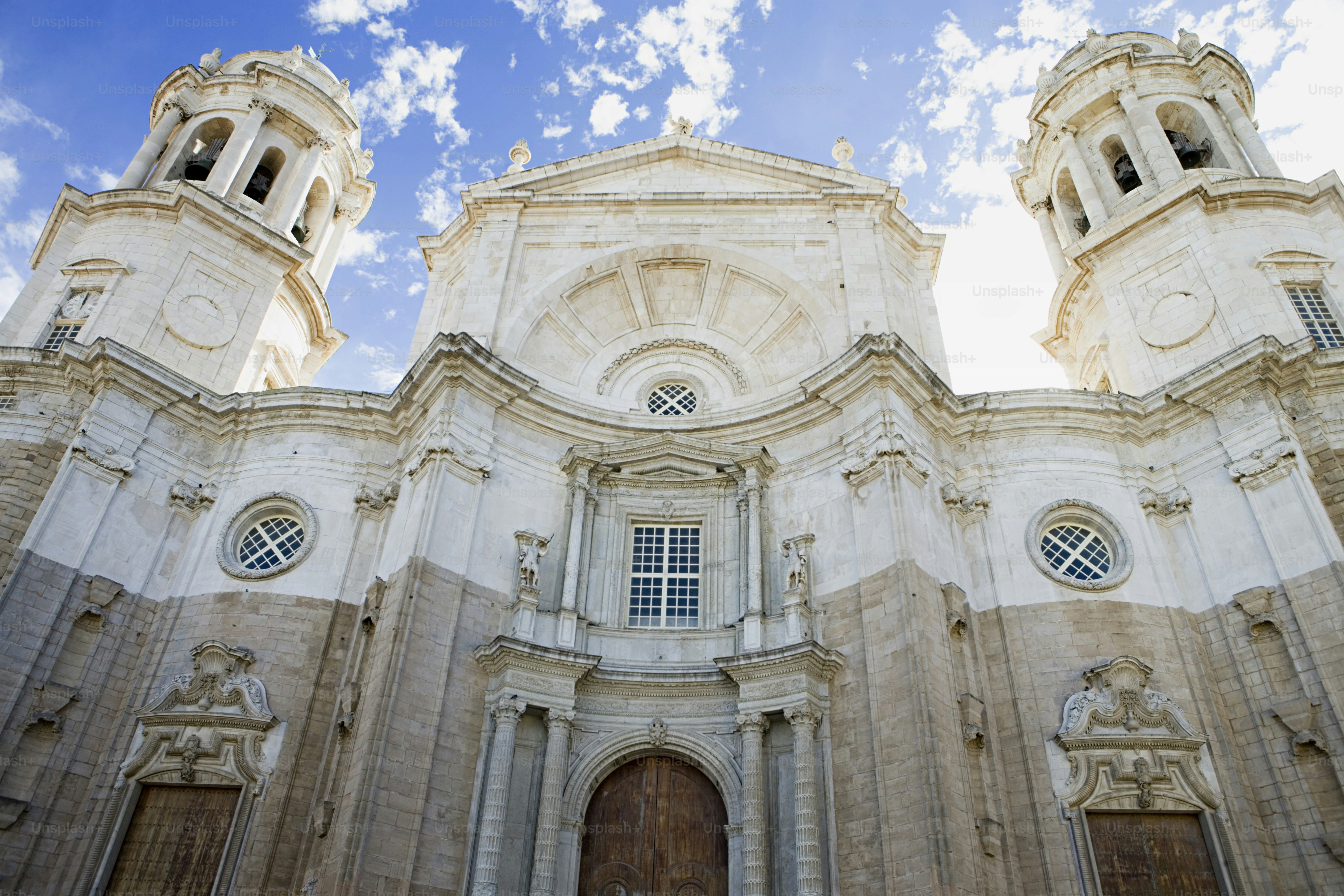 A large church with two towers and two doors photo – Cathedral Image on ...