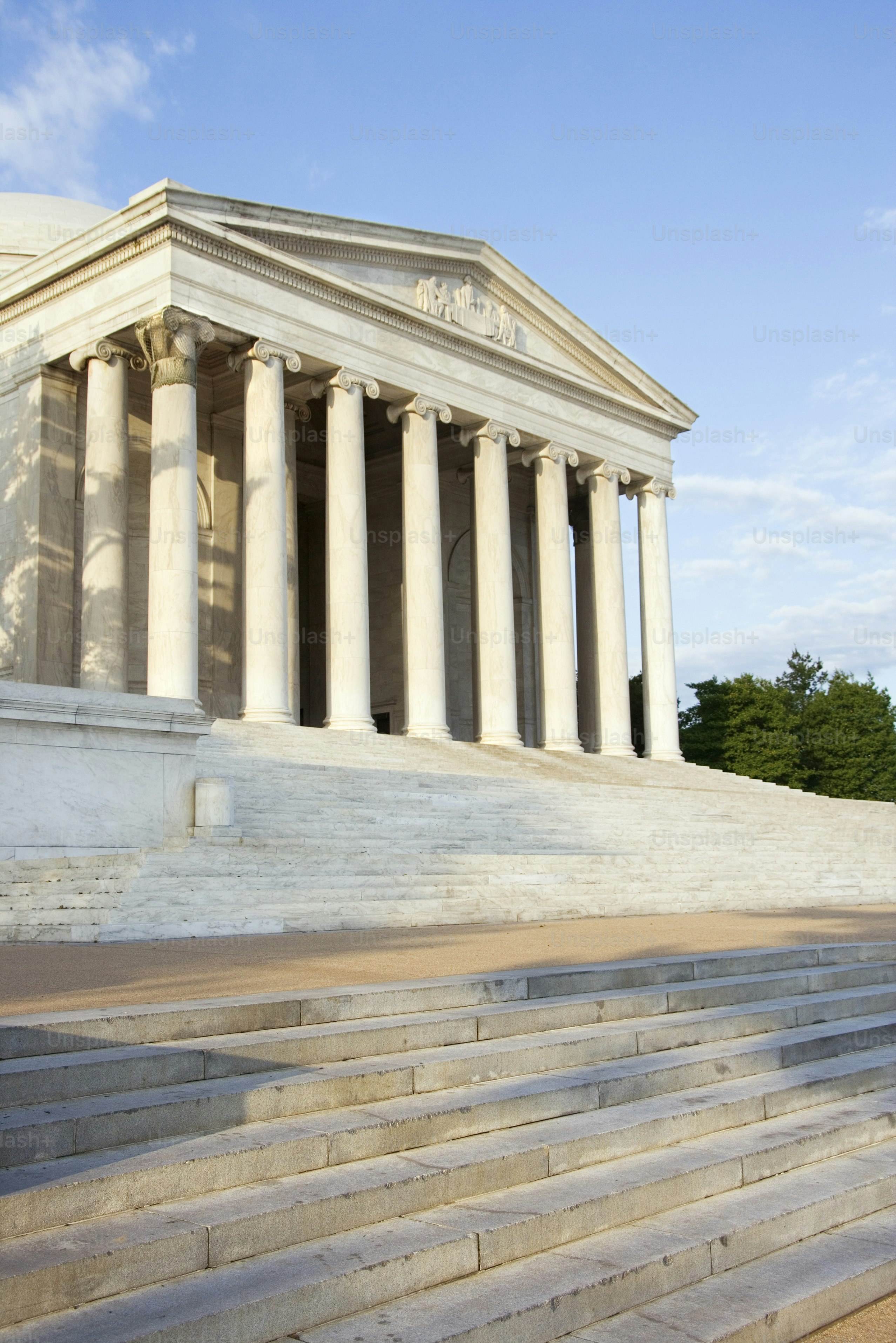 A large building with columns and steps leading up to it photo – Copy ...