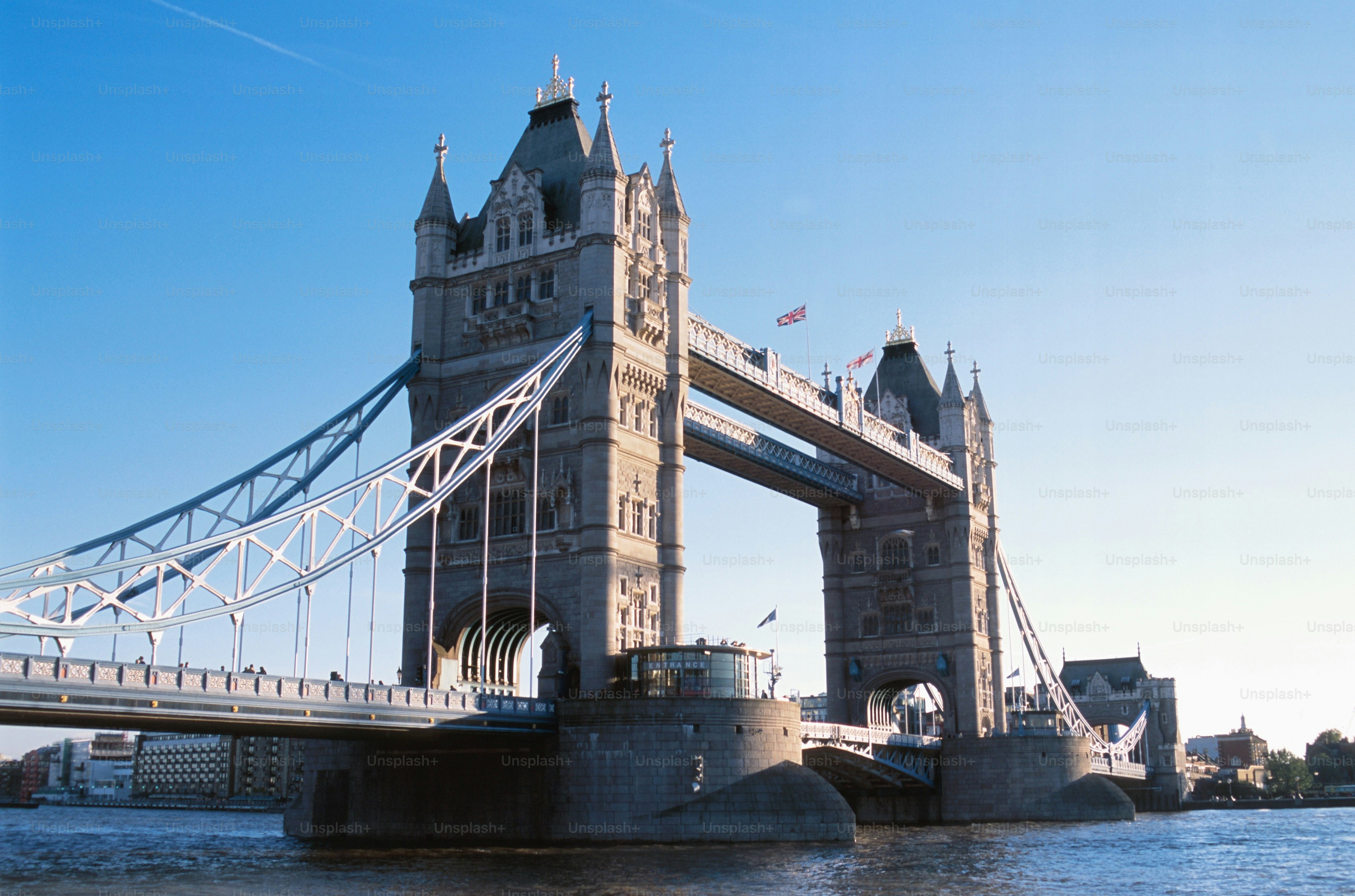 A tall bridge spanning over a body of water photo – Architecture Image ...