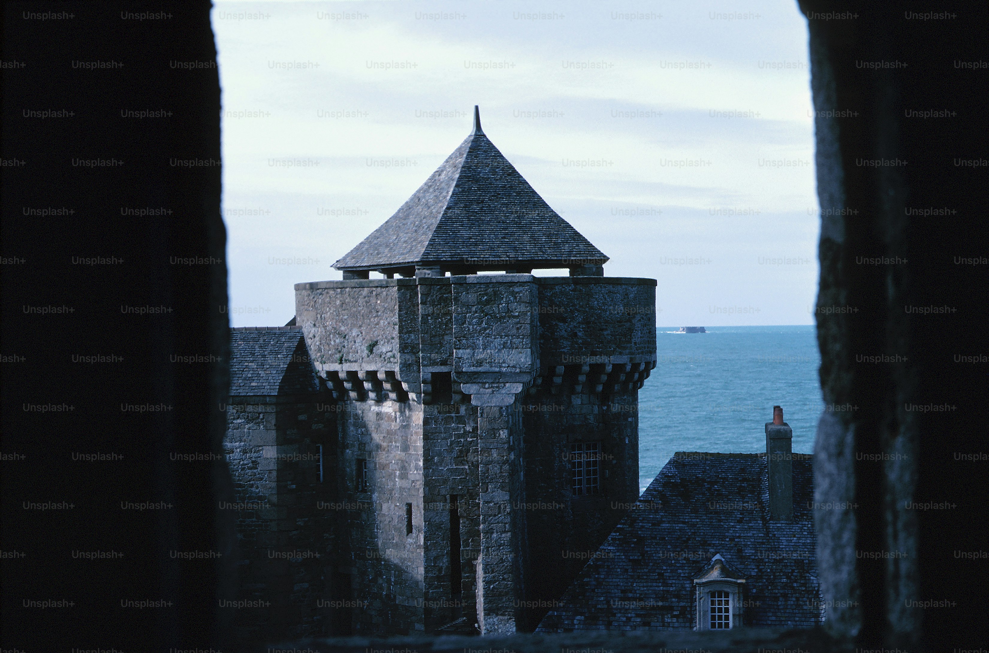 A view of the ocean from a window in a castle photo – Sea Image on Unsplash