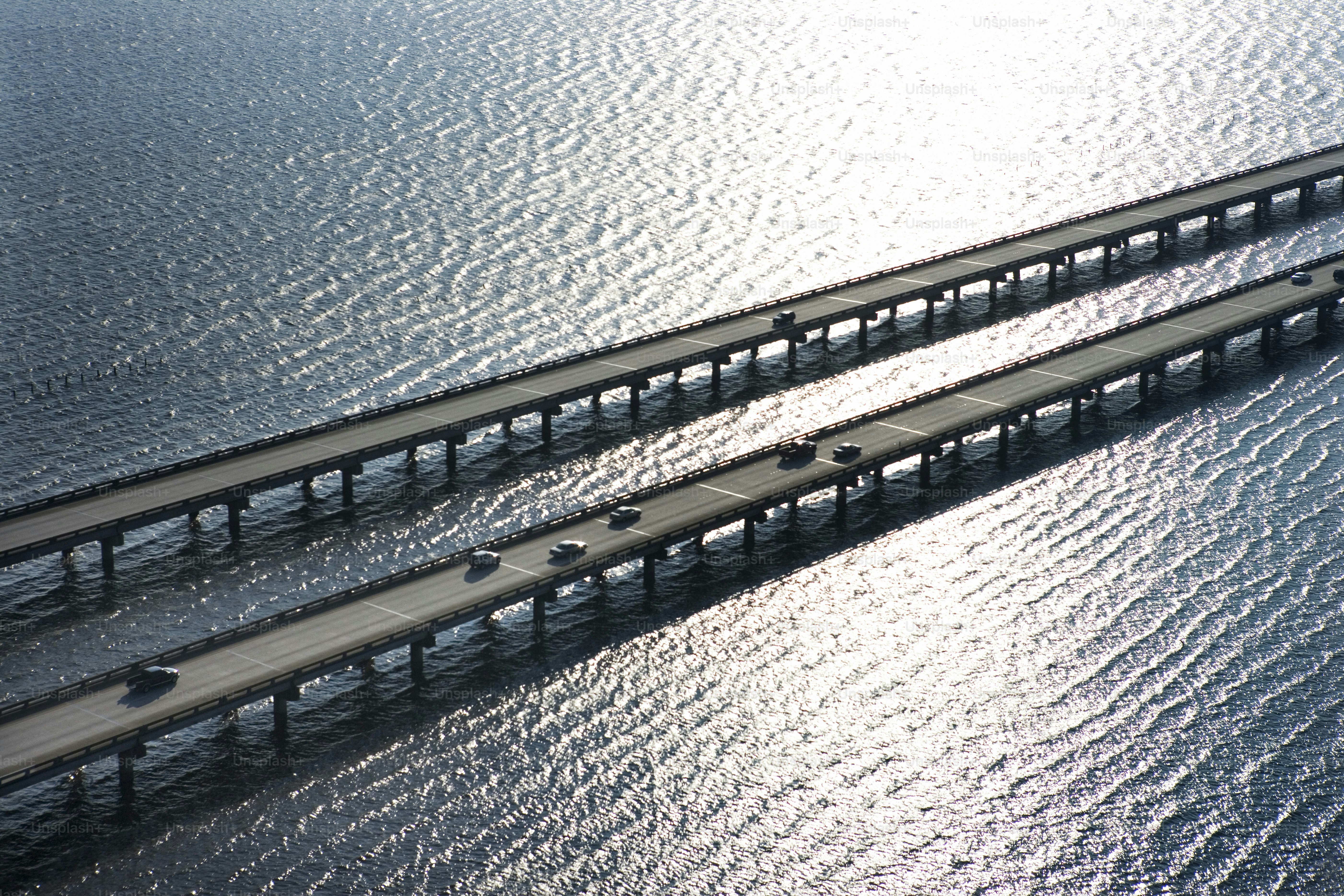 An aerial view of a bridge over a body of water photo – Transportation ...