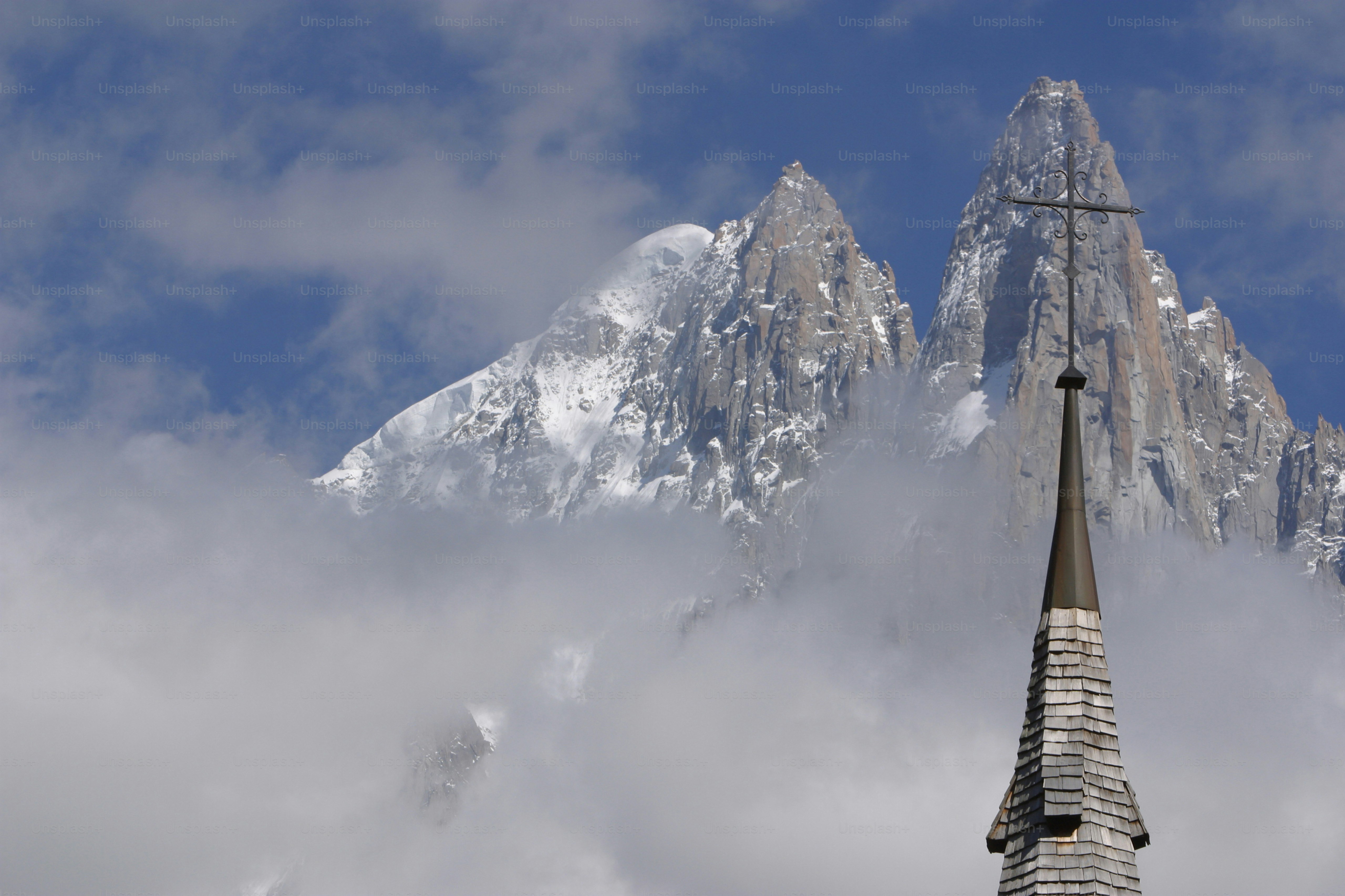 A church steeple with a mountain in the background photo – Mountain ...