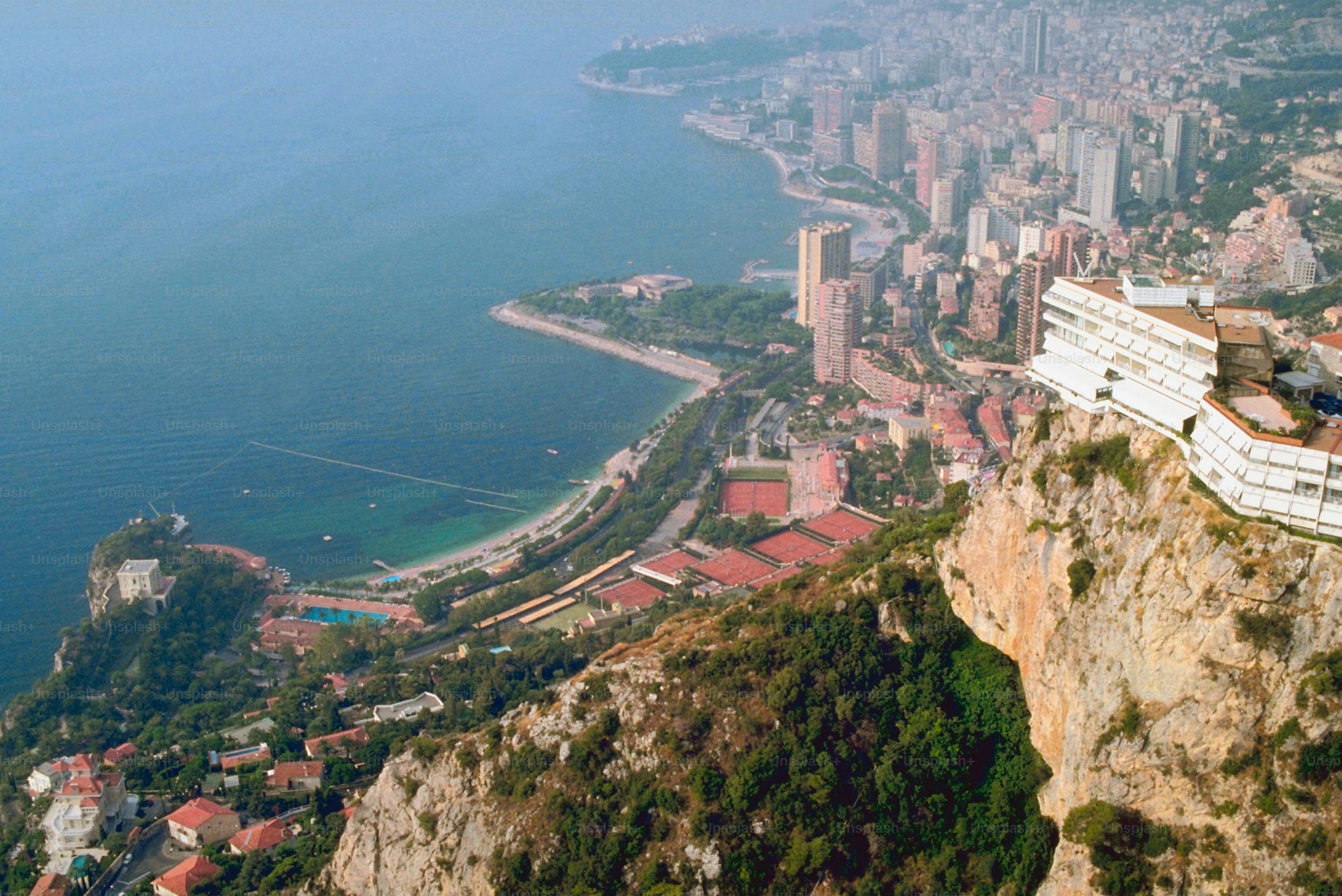 A bird's eye view of a city on the edge of a cliff photo – Skyscraper ...