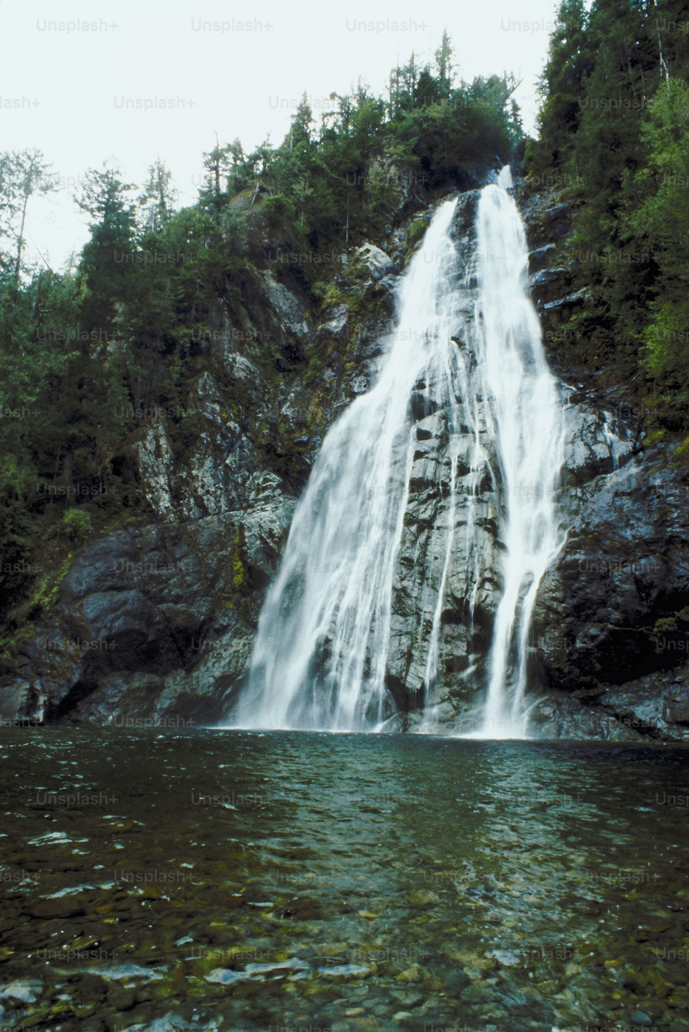 A large waterfall with lots of water coming out of it photo – Landscape ...
