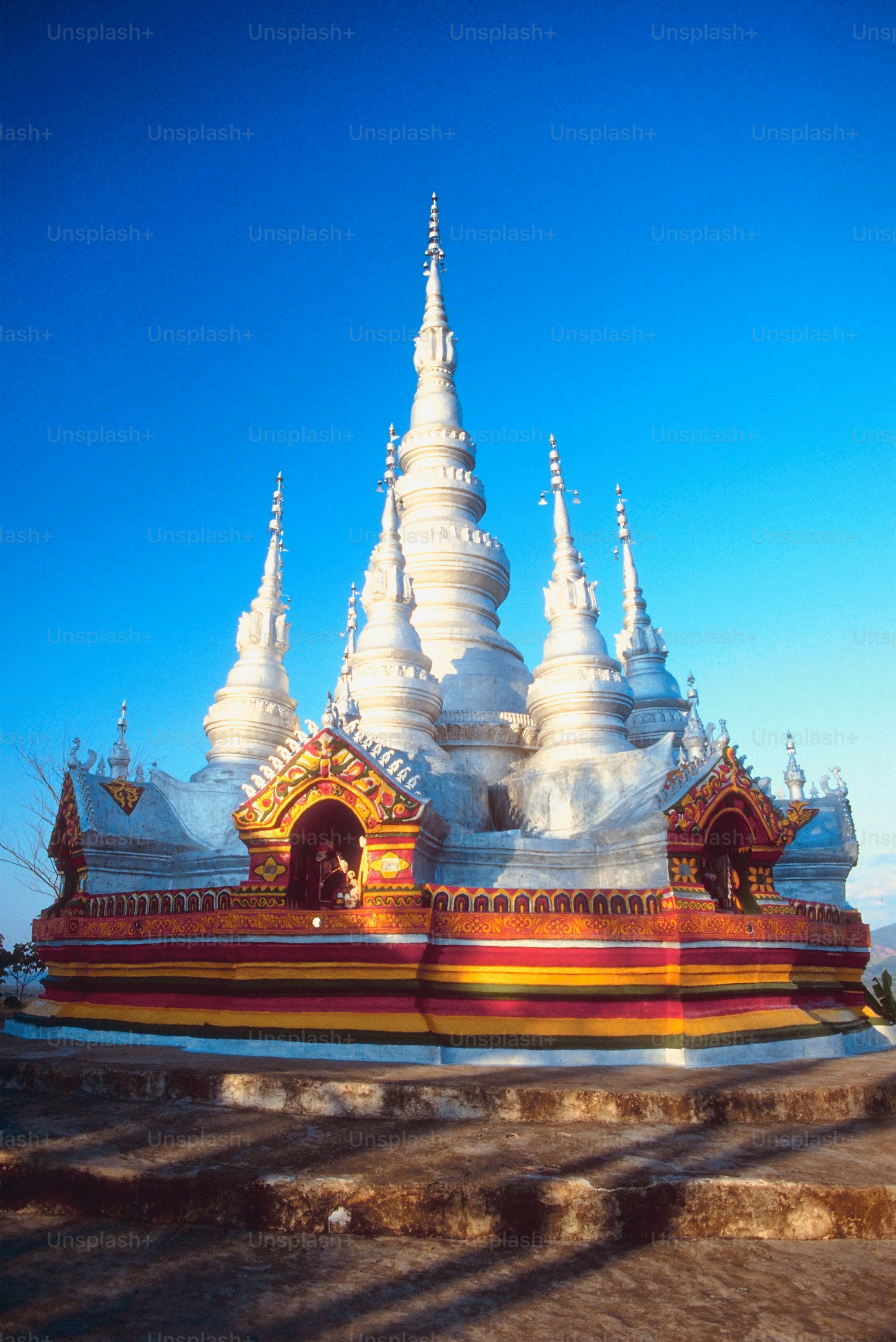 A large white building with many spires on top of it photo – Blue Image ...