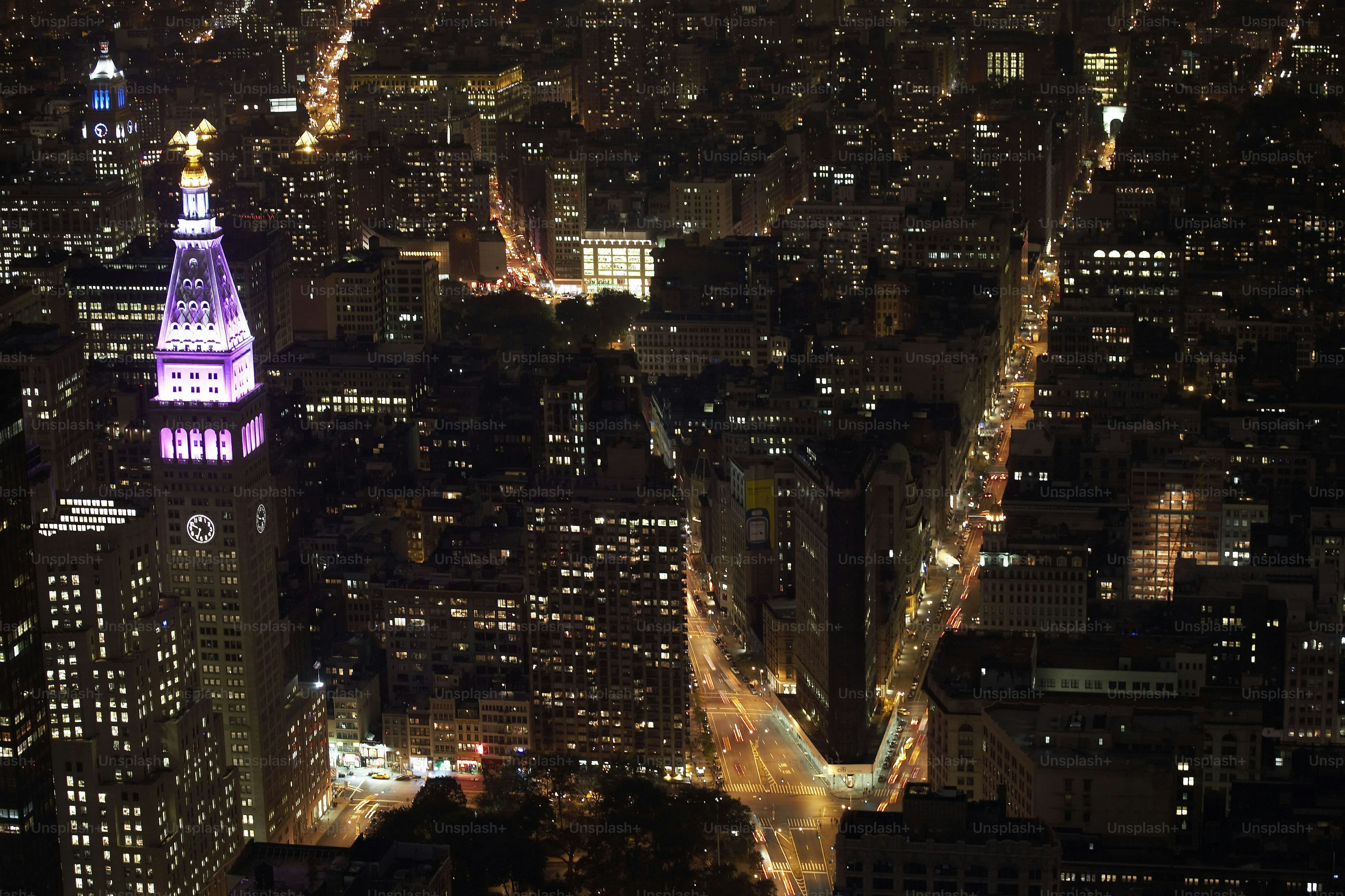 A view of a city at night from the top of a building photo ...