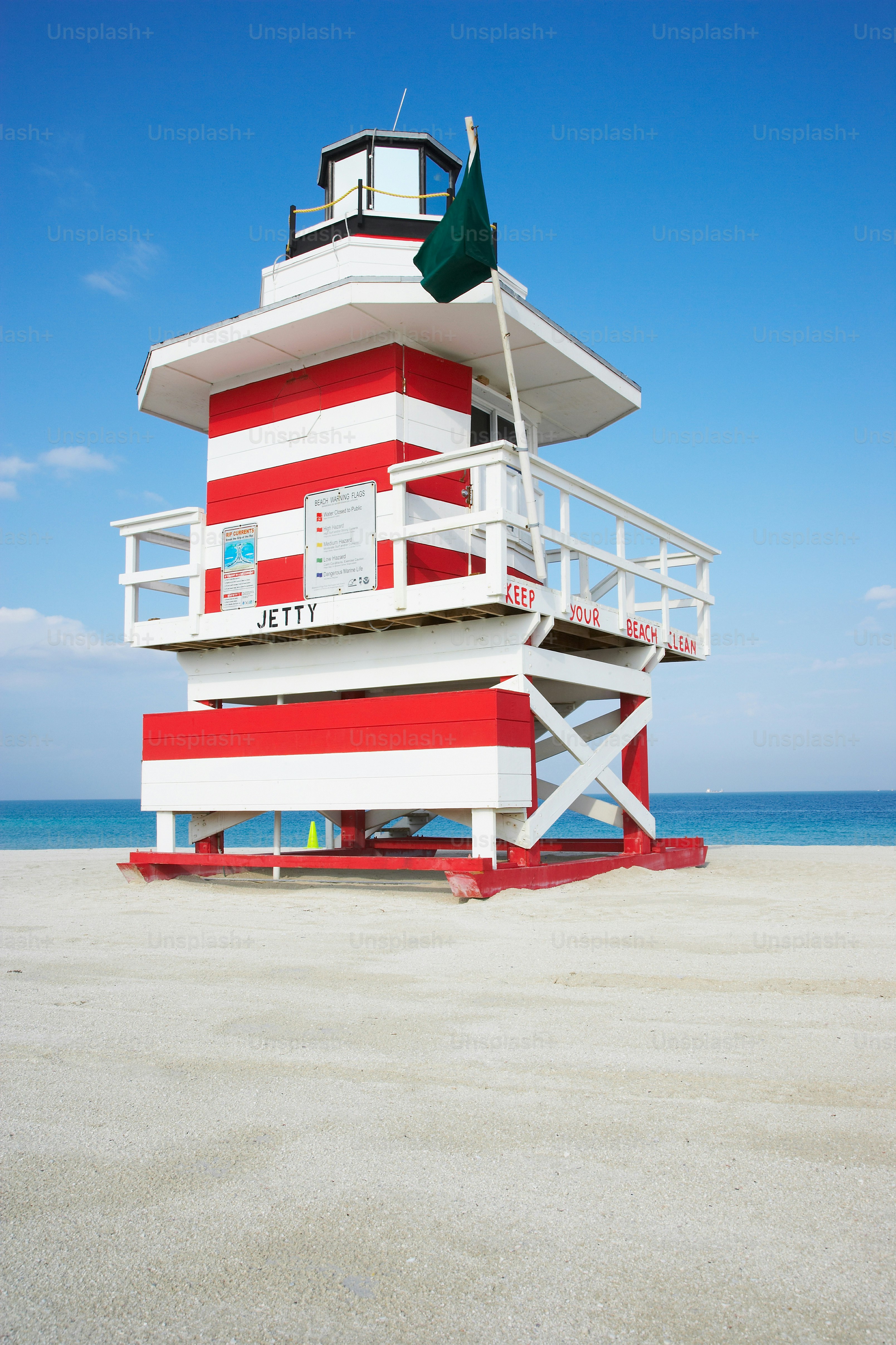 A red and white lifeguard tower on the beach photo – Copy space Image ...