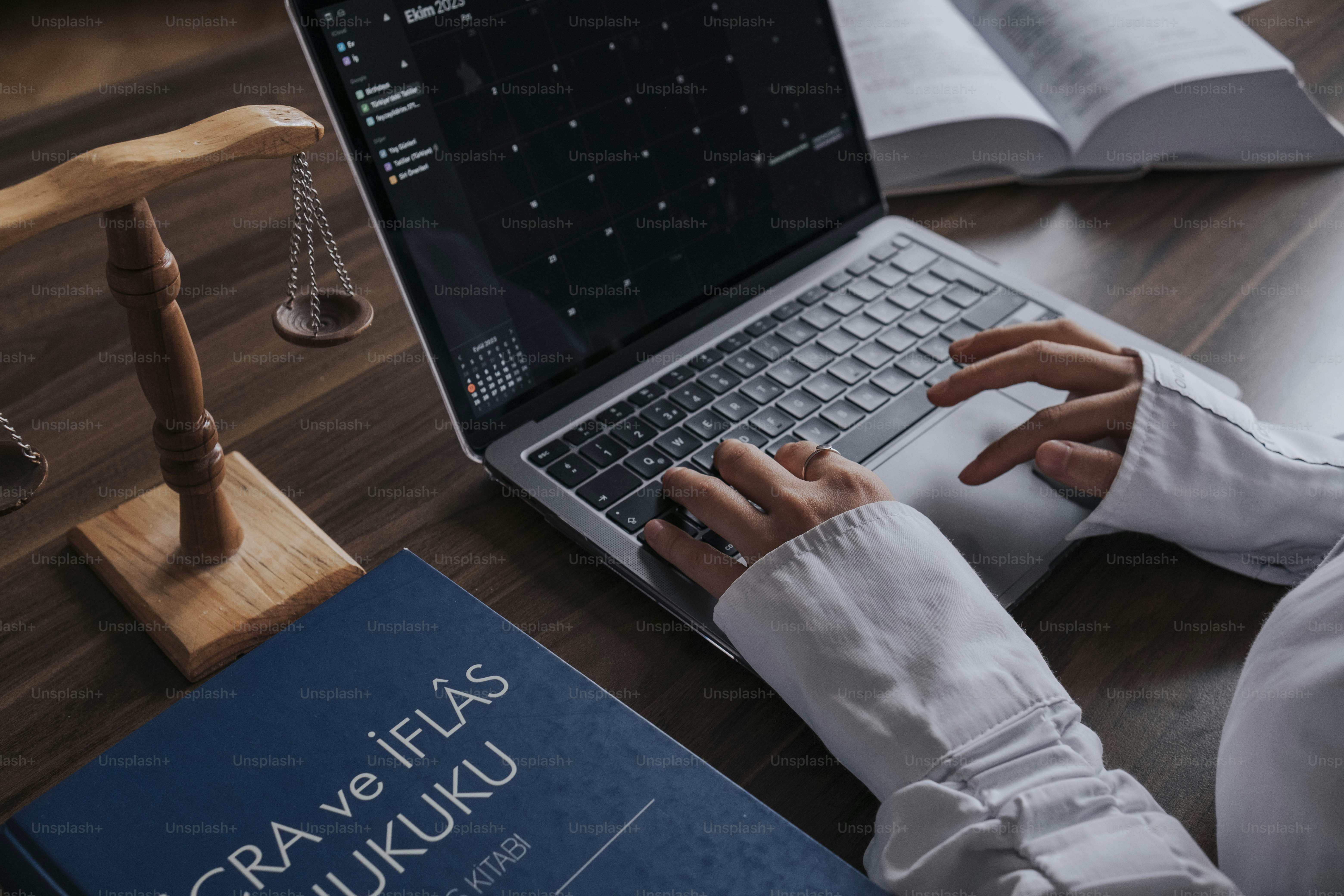 A person sitting in front of a laptop computer photo – Solicitor Image ...