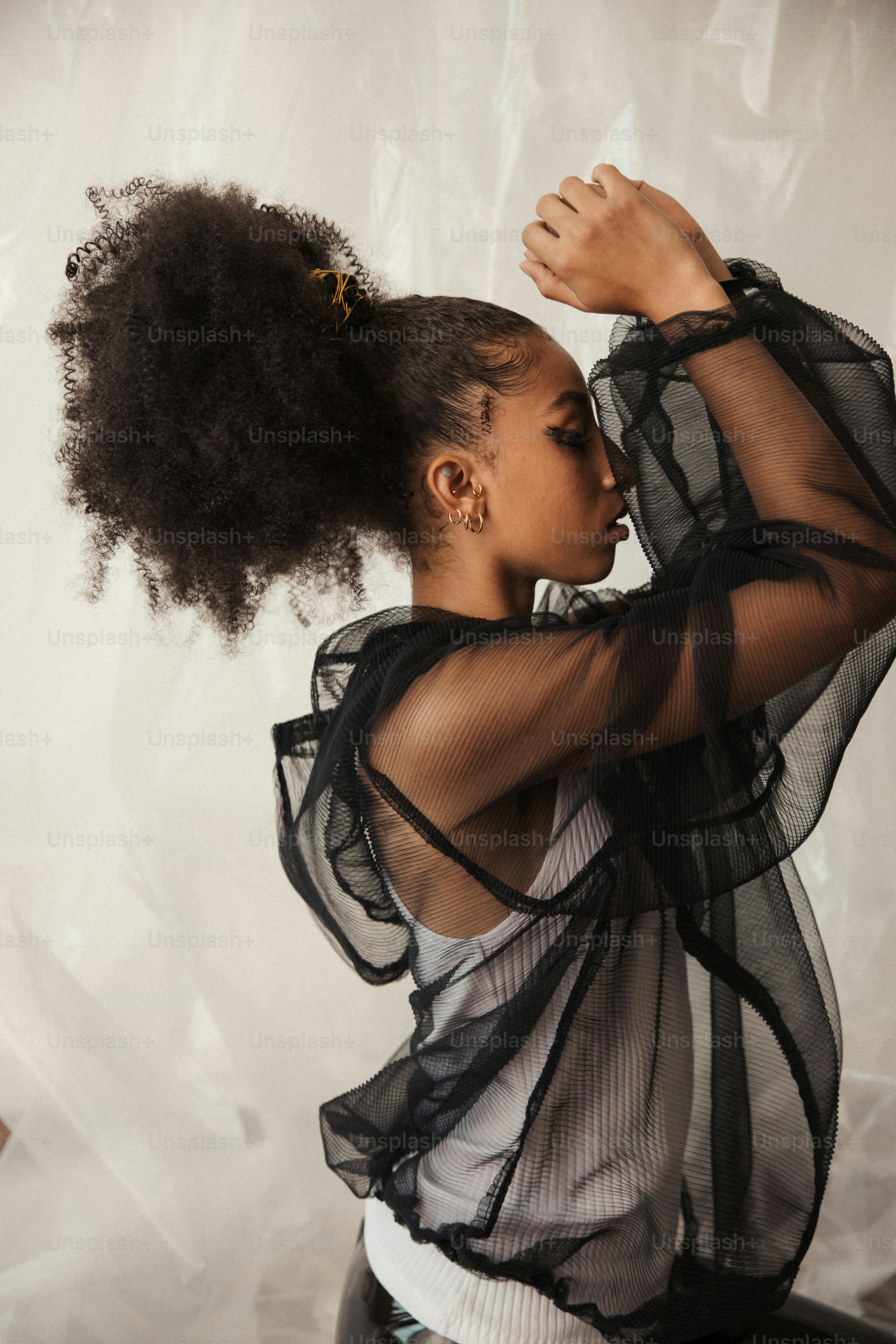 A woman with an afro is posing for a picture photo – Female Image on ...