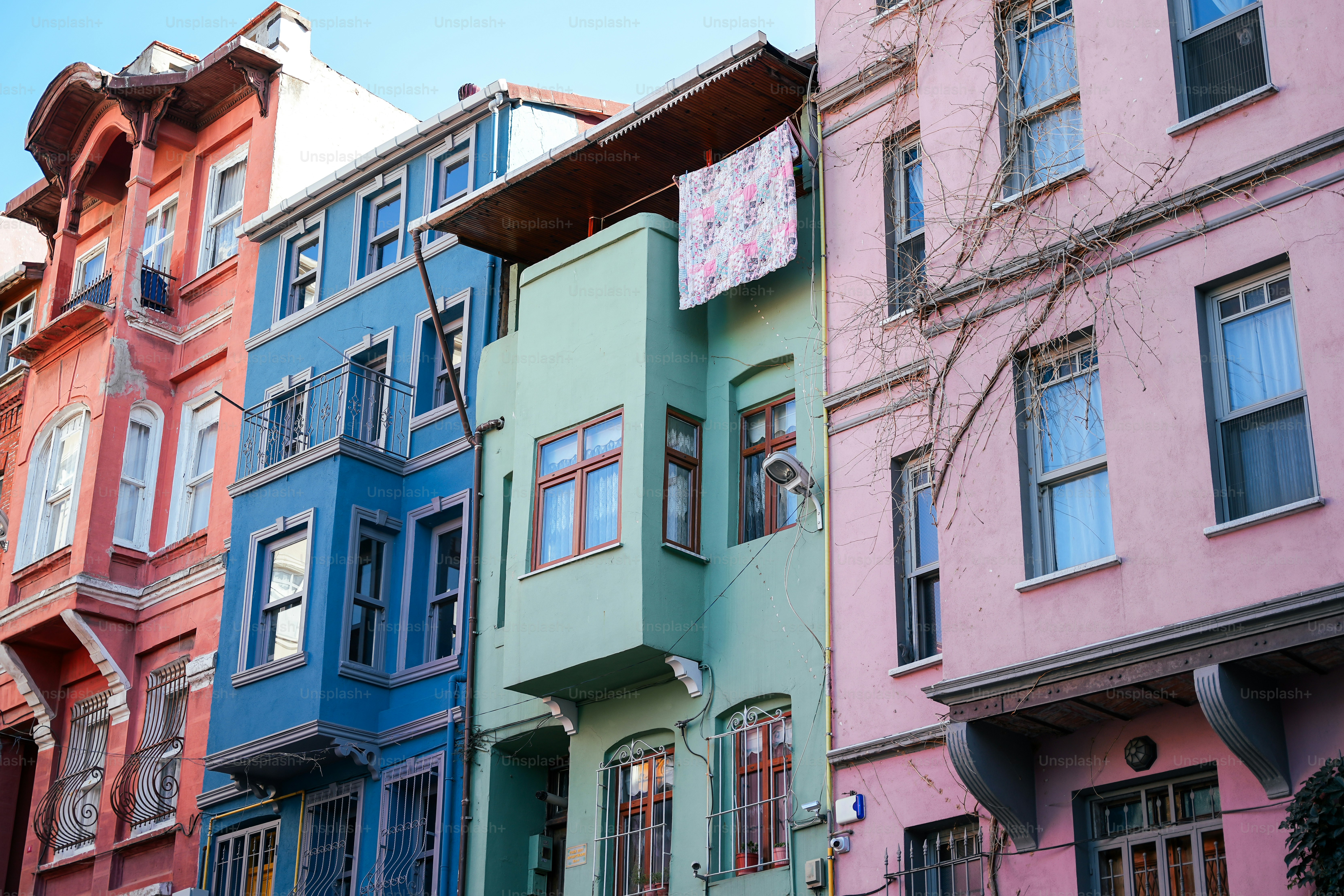 A row of multicolored buildings in a city photo – Colorful architecture ...