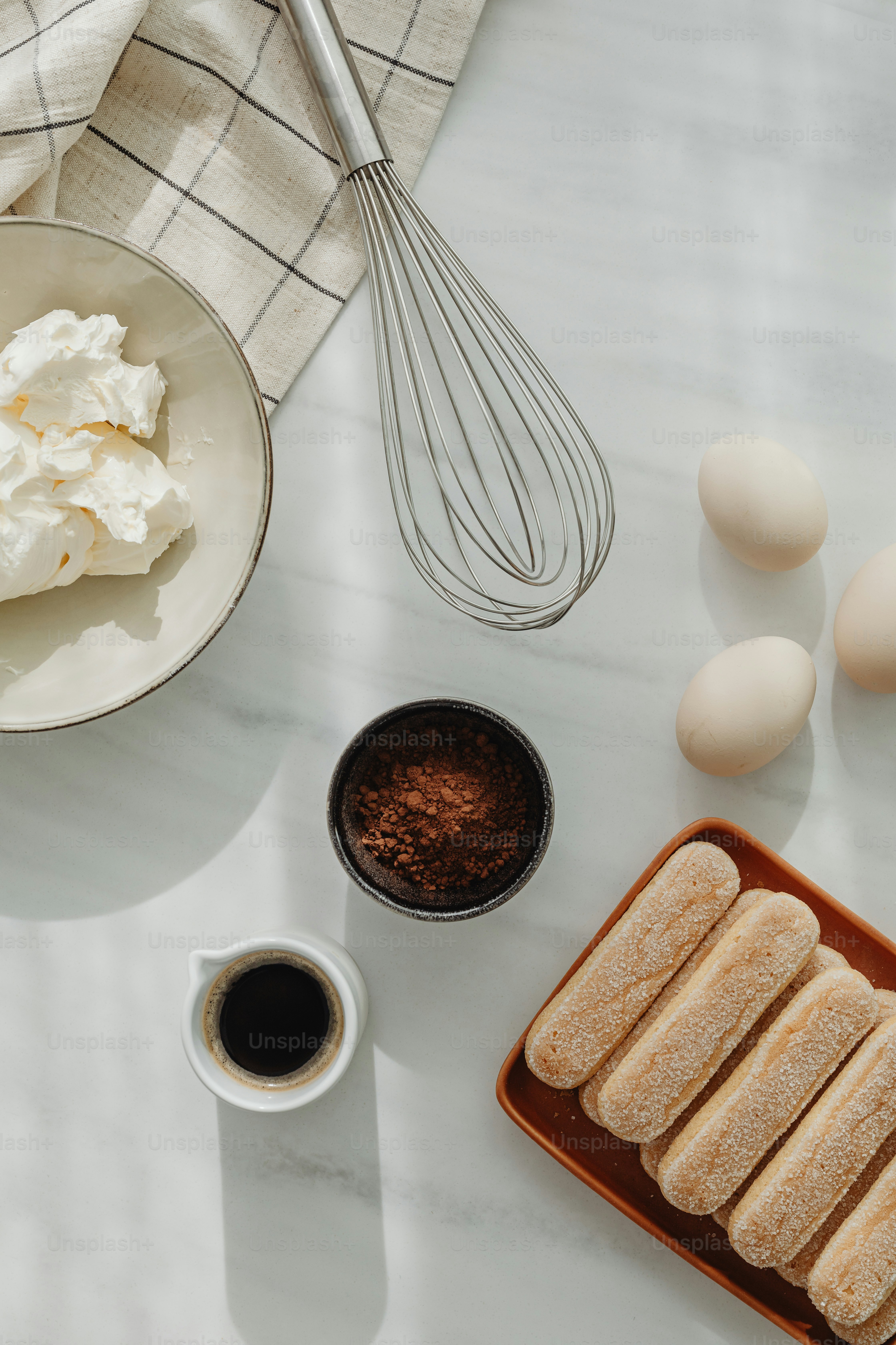 A table topped with a bowl of cream and a plate of bread photo – Food ...