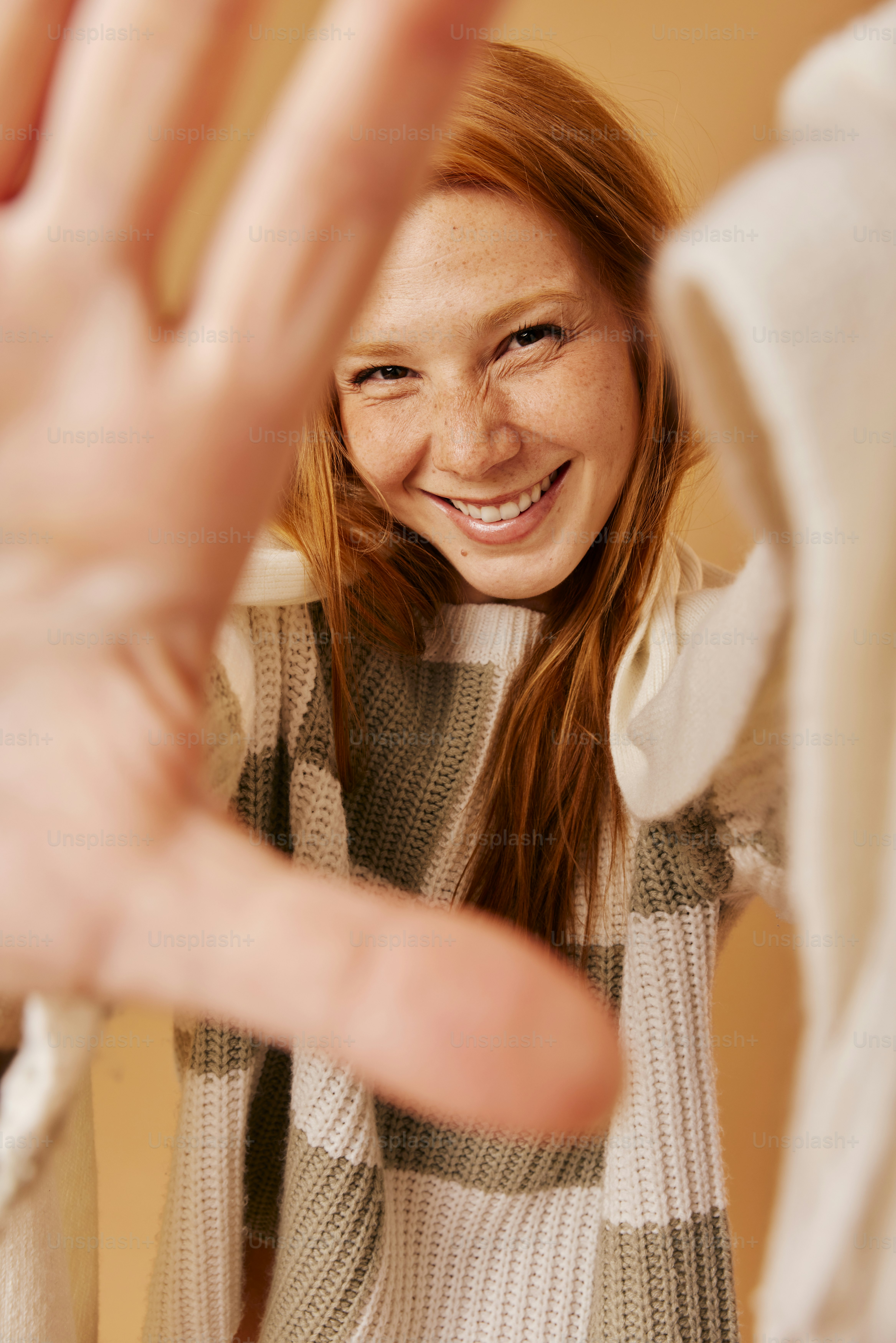 A woman is smiling and making a hand gesture photo – Autumn Image on ...