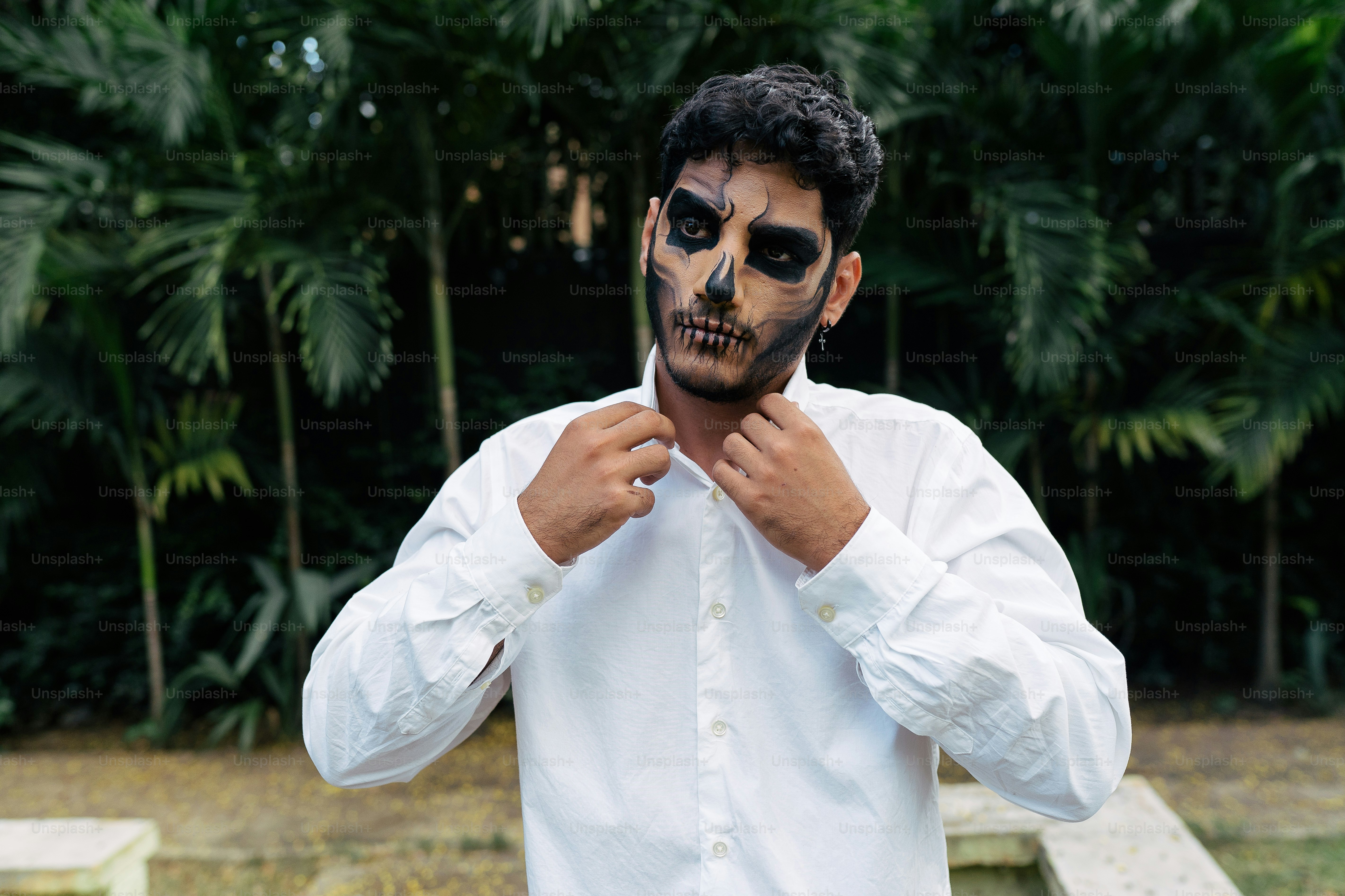 A man with a skull face painted on his face photo – Halloween makeup ...