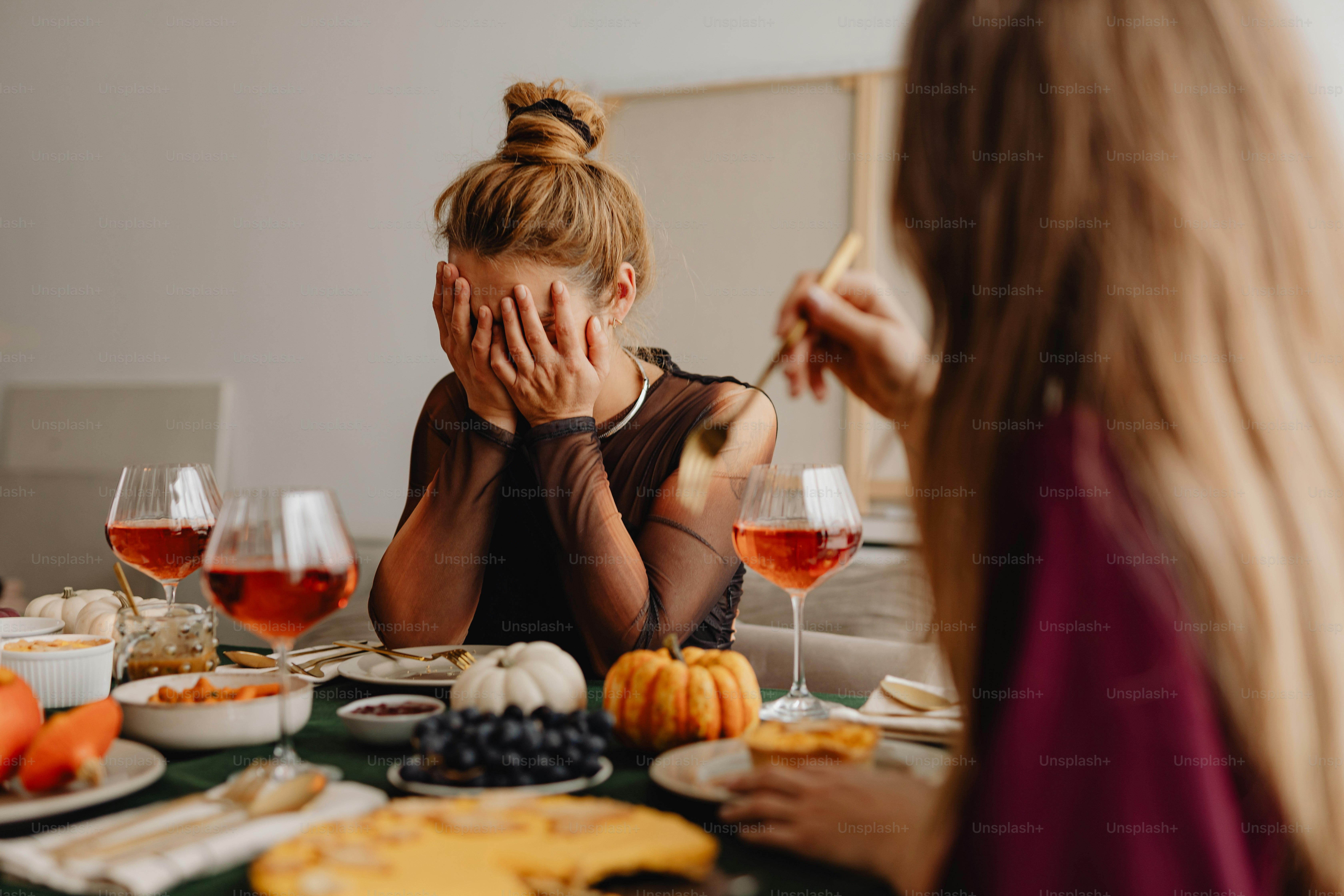 A group of people sitting around a table with food photo – Thanksgiving ...
