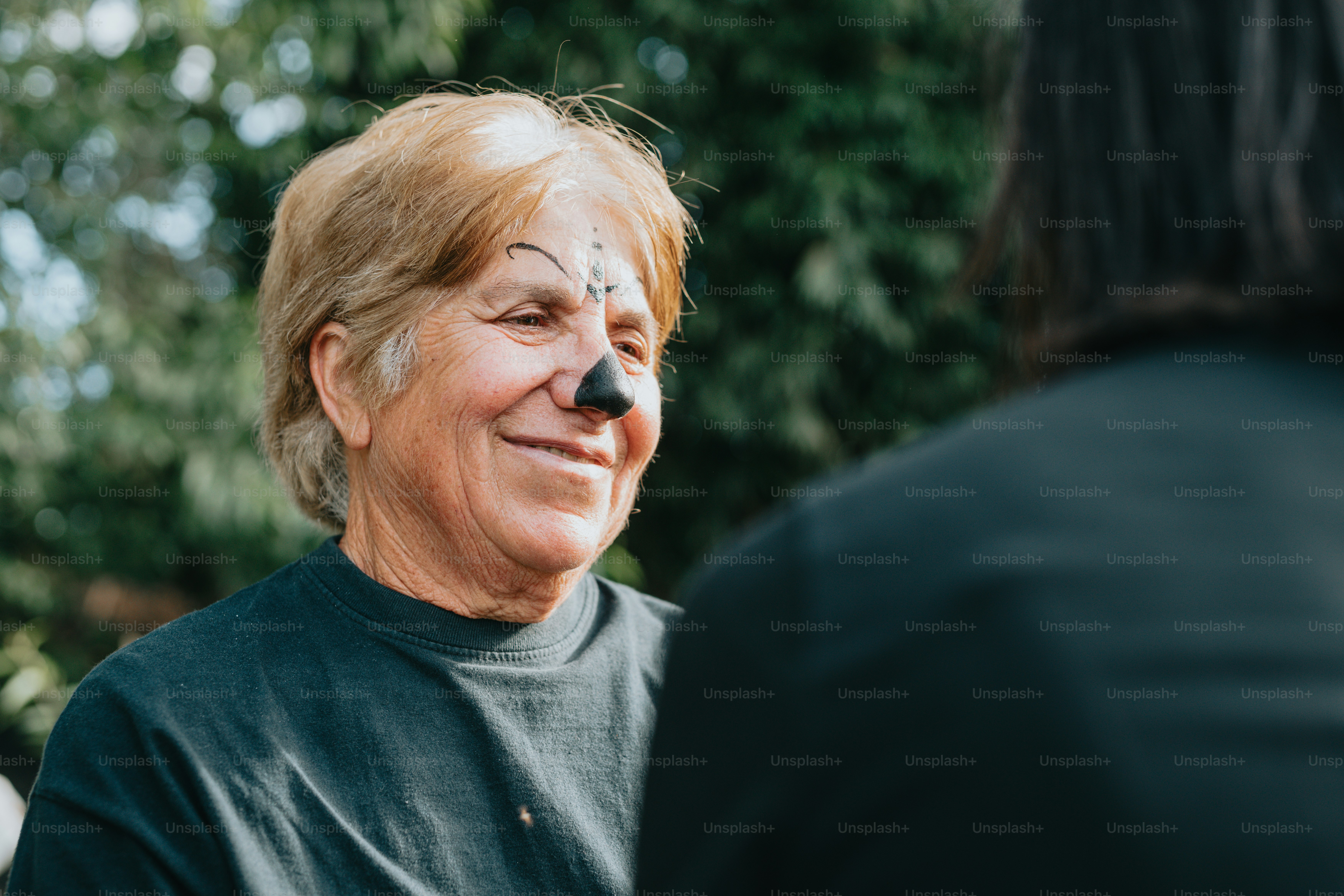 A woman with a clown nose and nose ring photo – Halloween Image on Unsplash