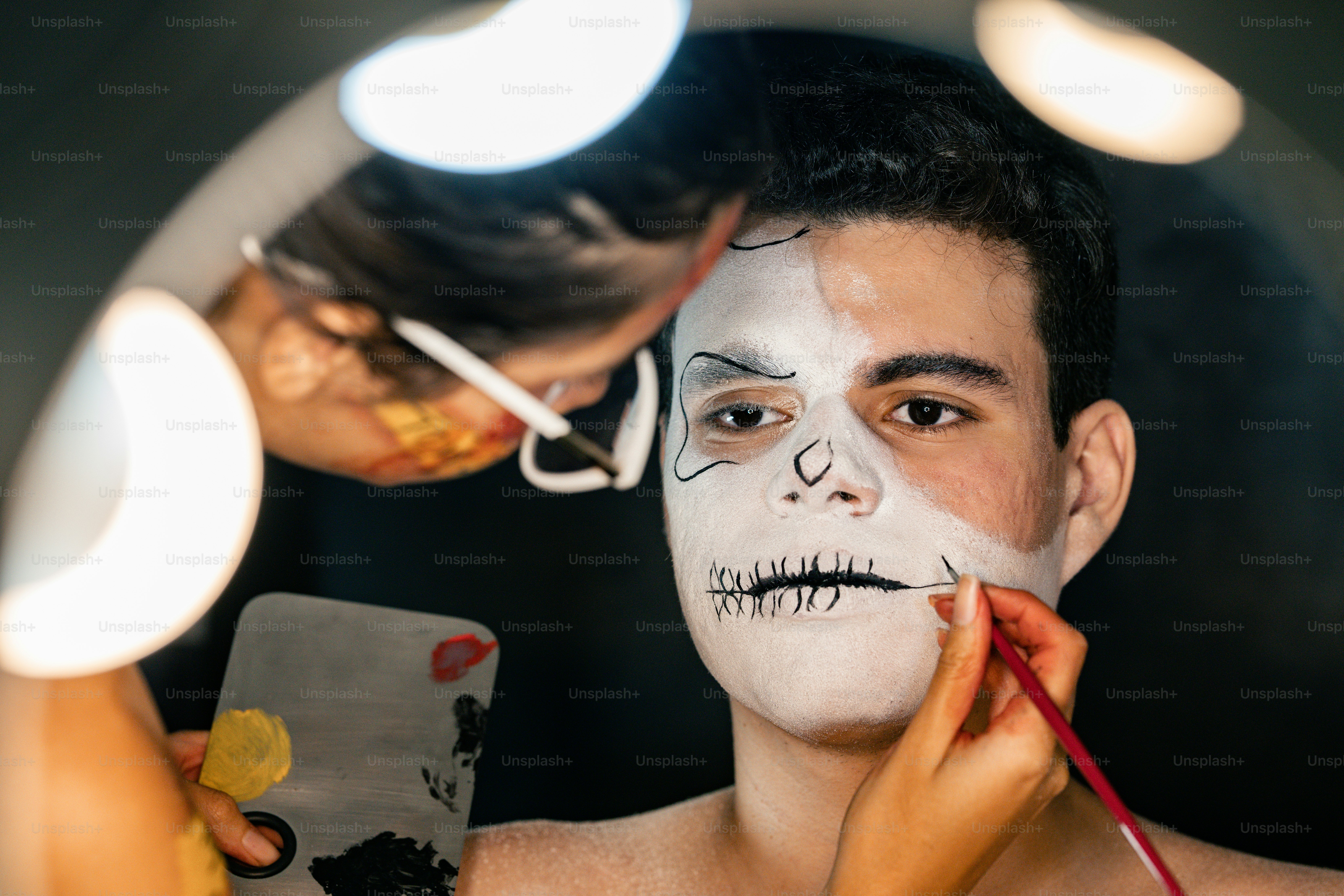 A man is getting his face painted photo – Halloween costume Image on ...