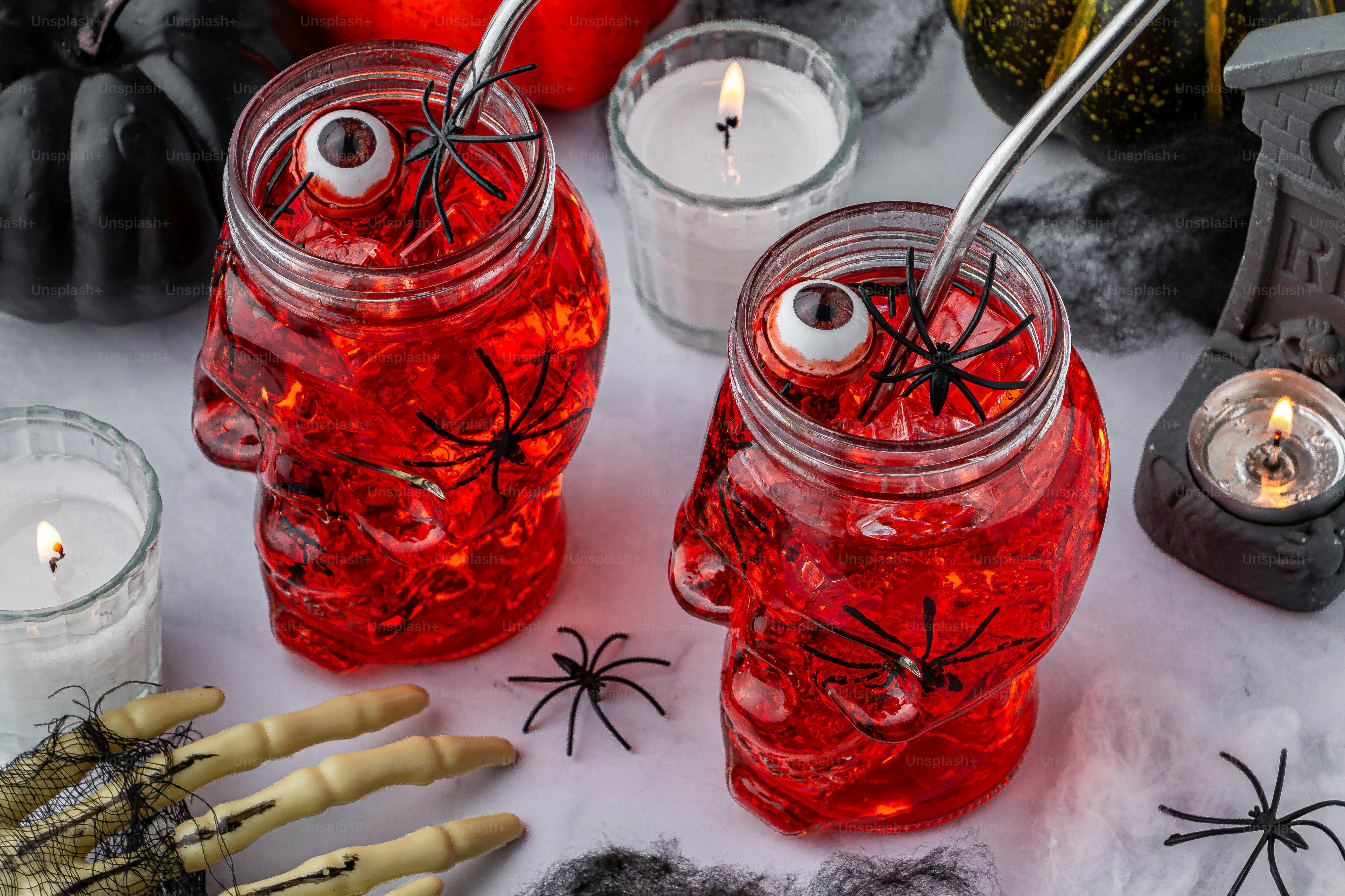 A table topped with jars filled with liquid and halloween decorations ...
