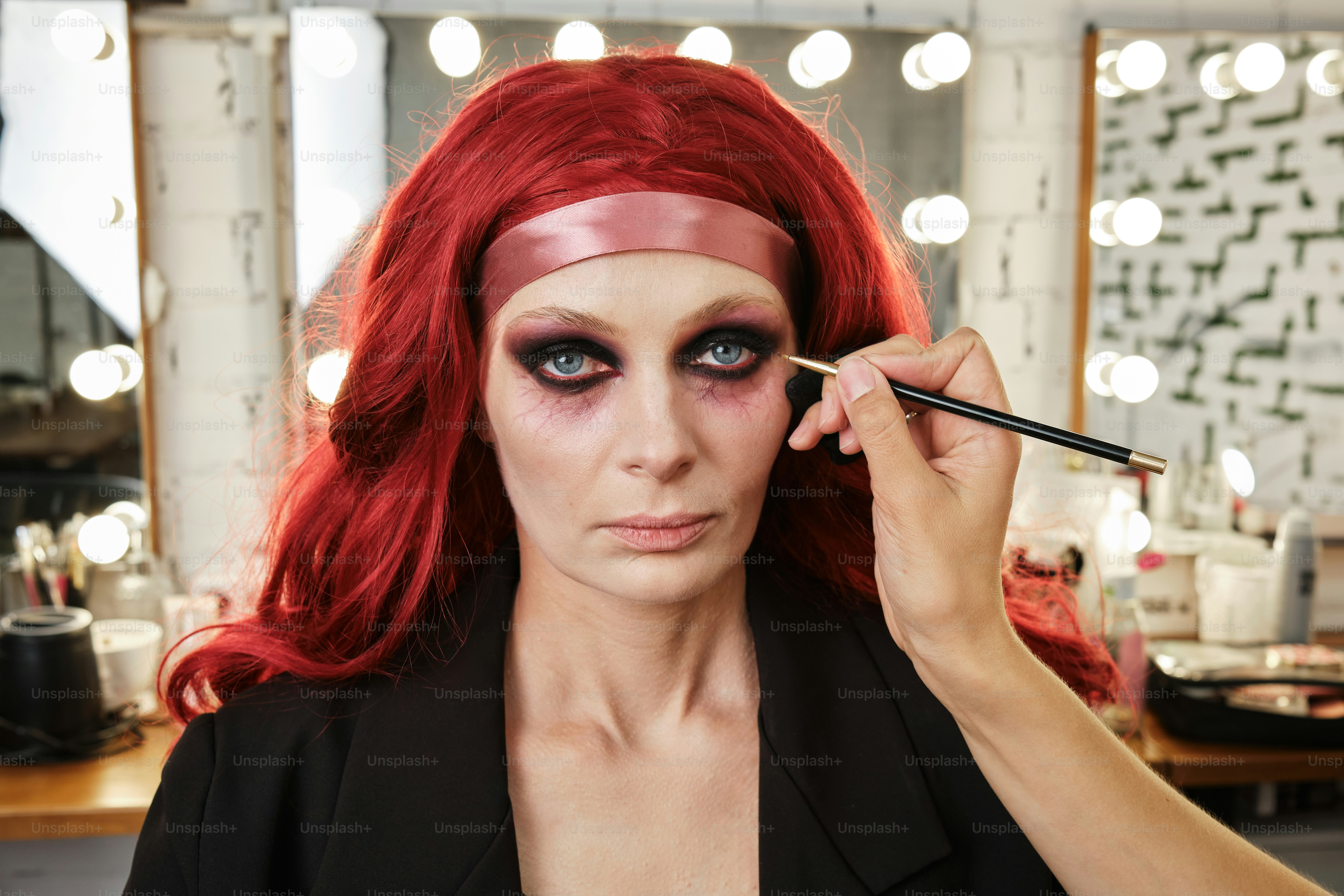 A Woman With Red Hair Is Doing Makeup Photo Make Up Image On Unsplash