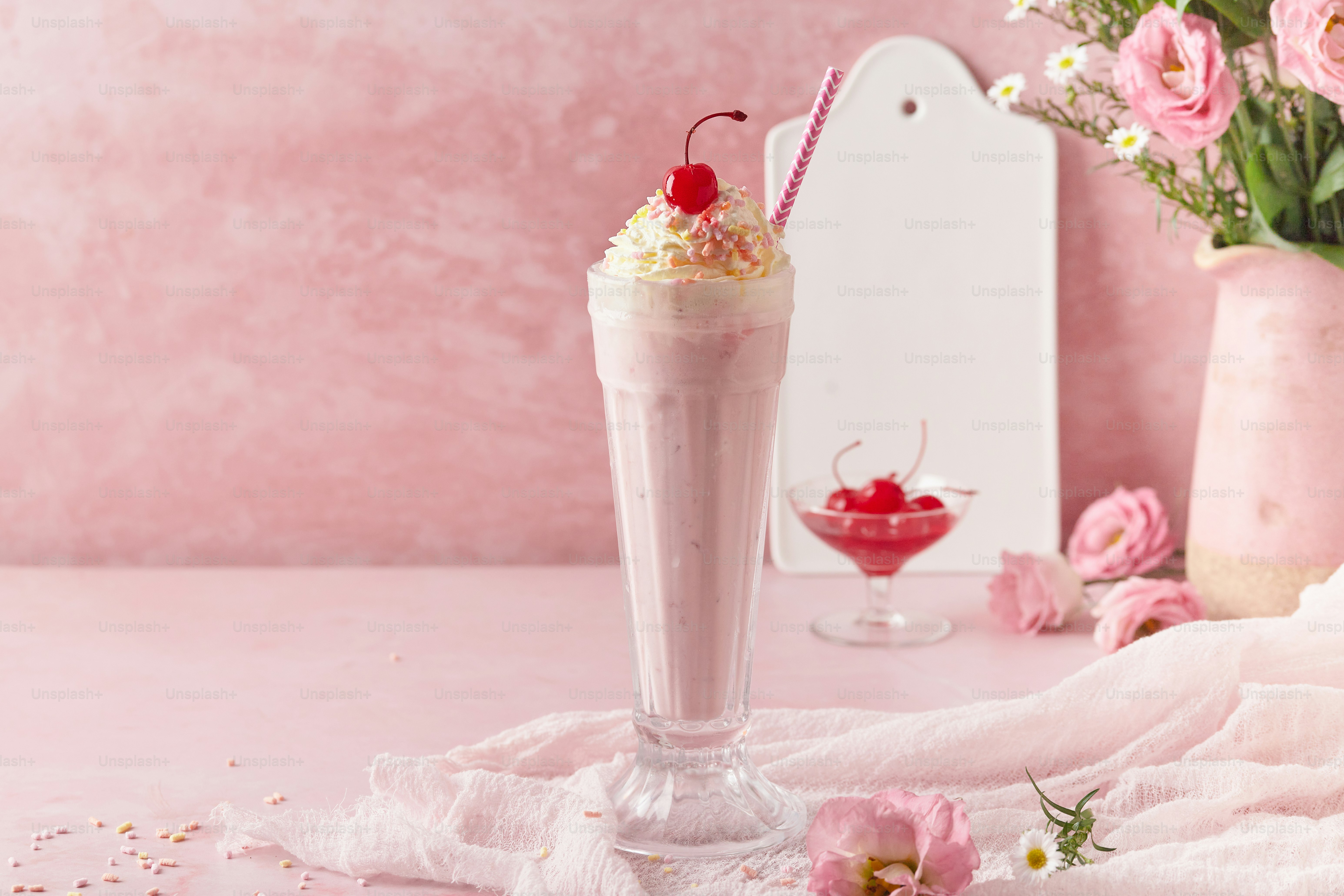 A milkshake with whipped cream and a cherry garnish photo – Food ...