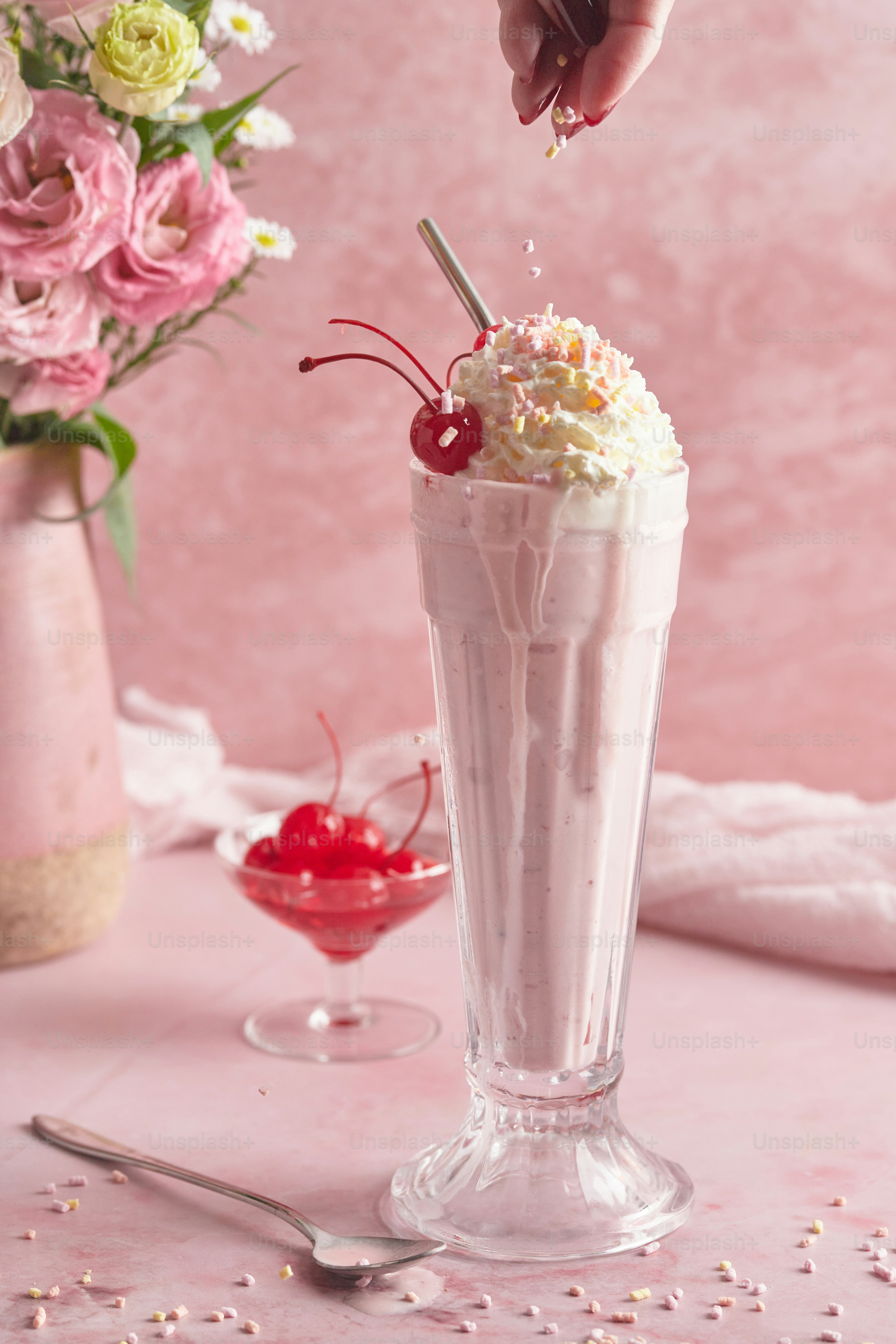 A pink table topped with ice cream and cherries photo – Food Image on ...