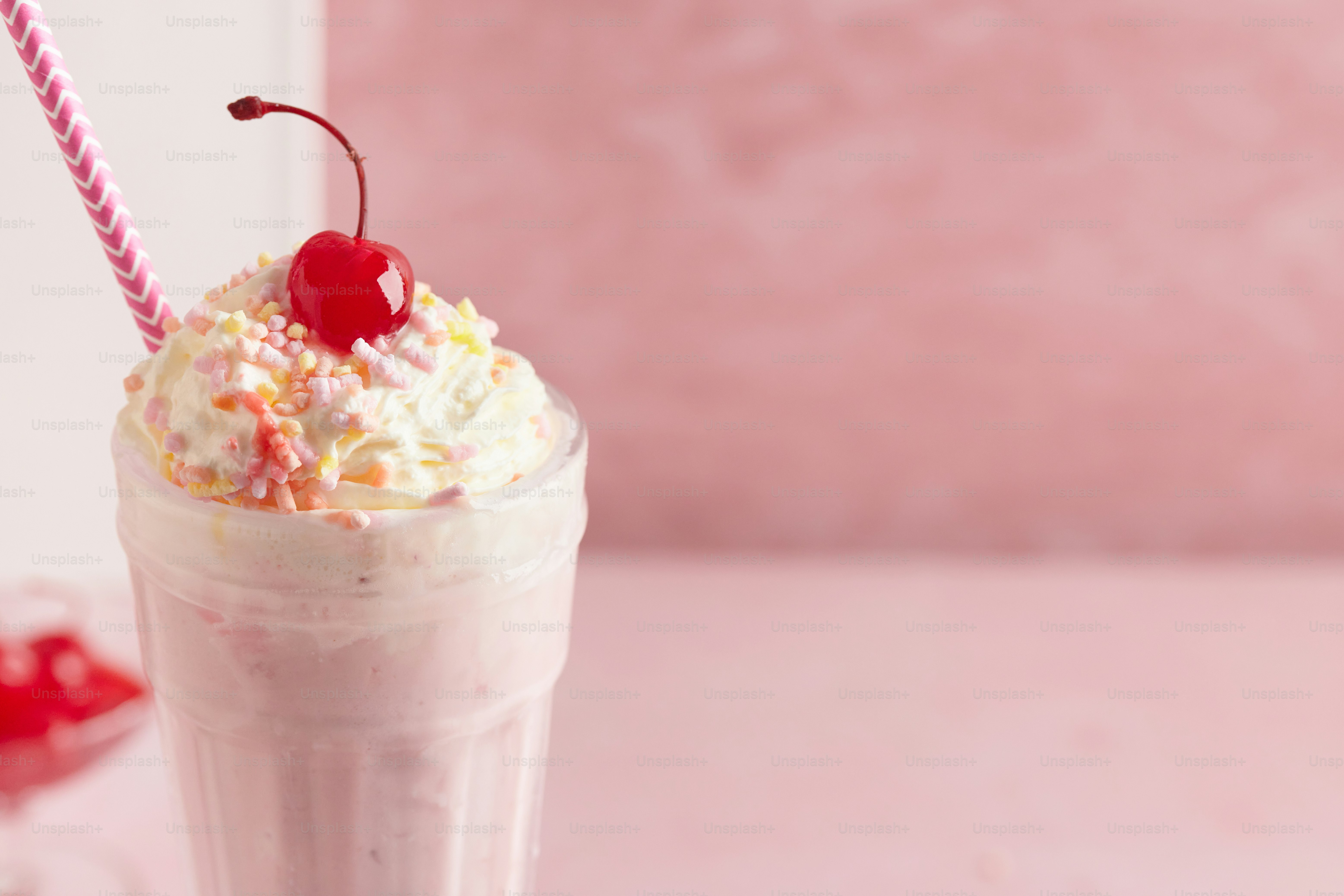 A milkshake with whipped cream and a cherry garnish photo – Food ...