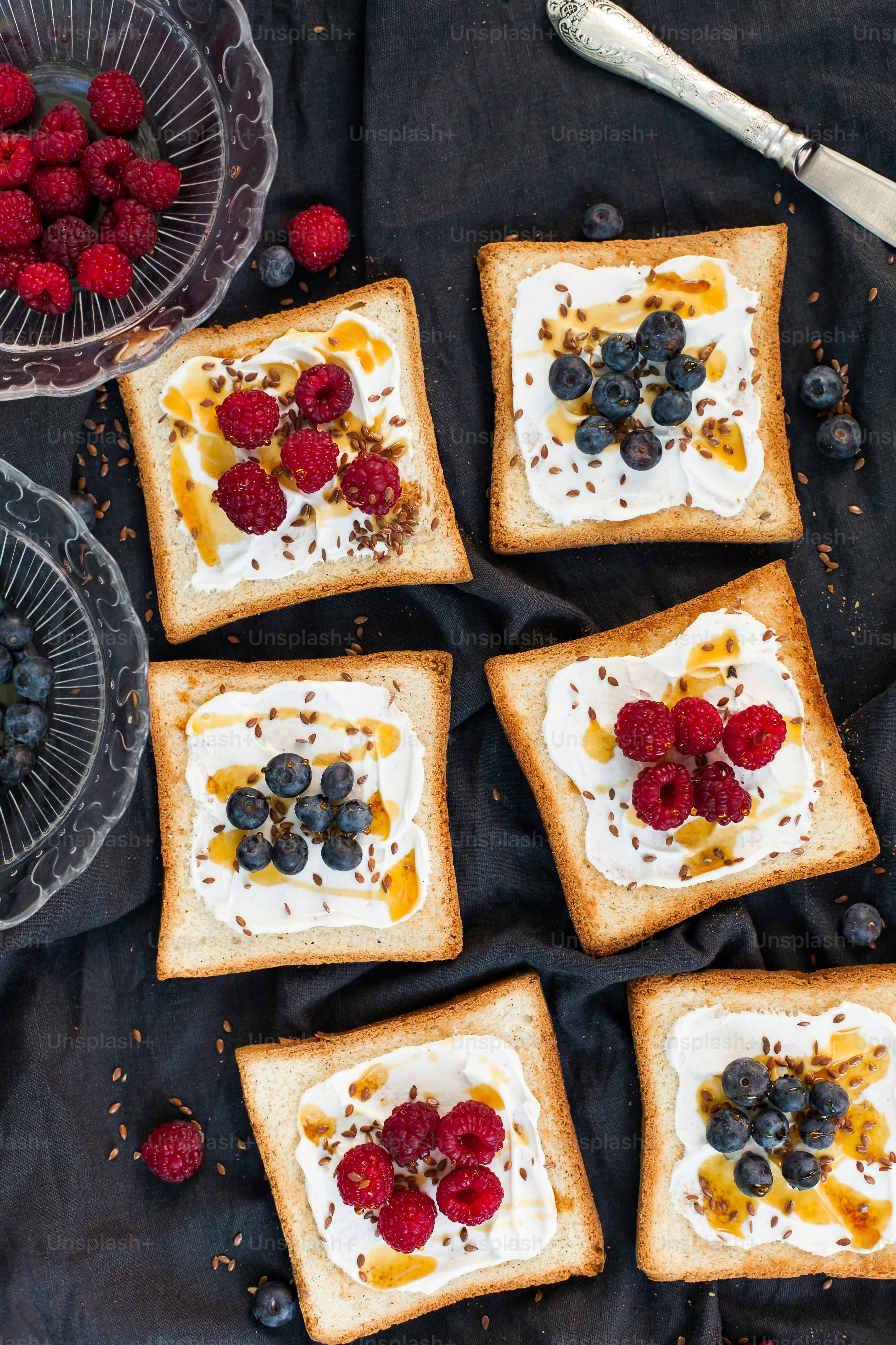 Four pieces of toast topped with fruit and cream photo – Toast Image on ...