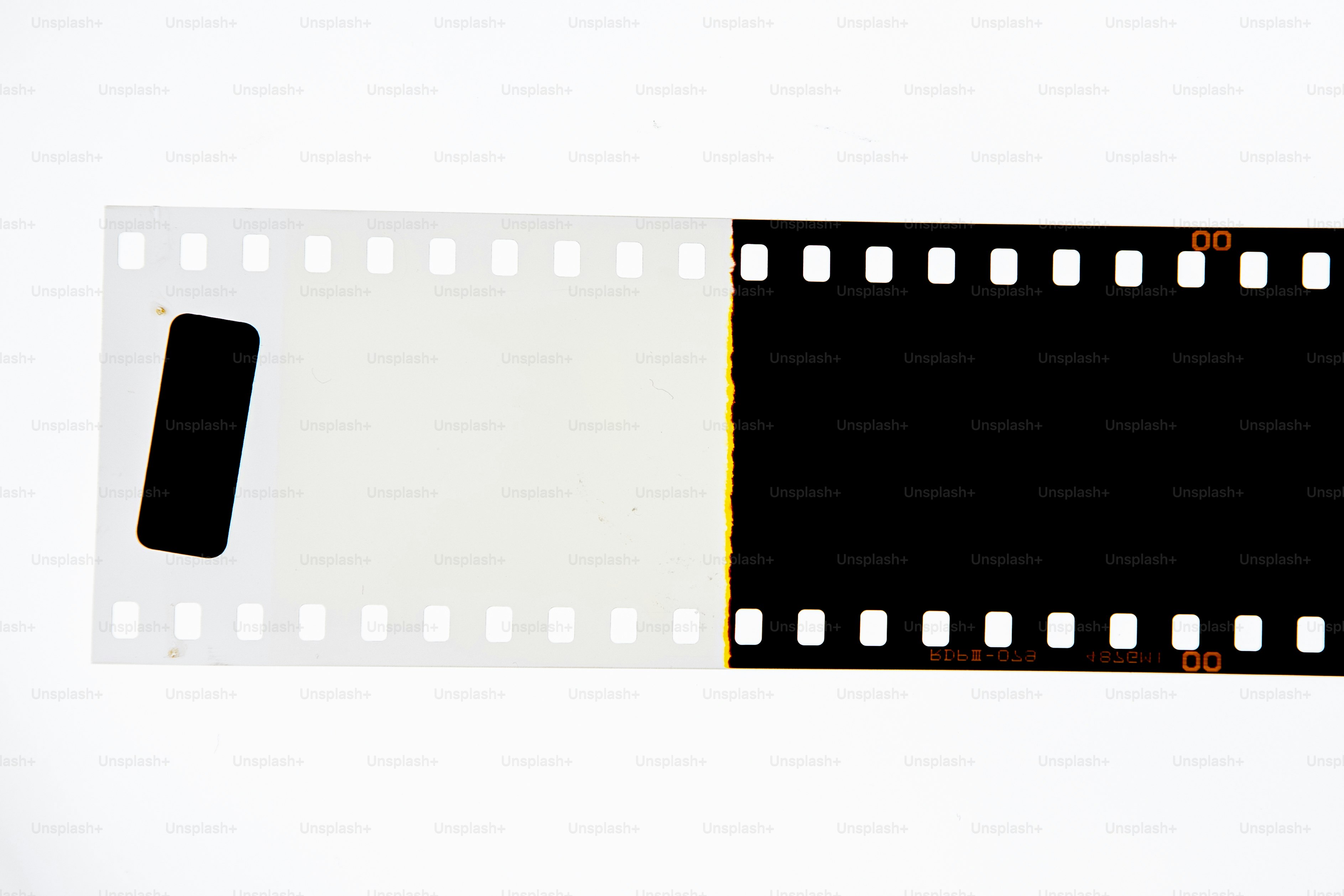 A film strip with a black and yellow strip photo – Analog Image on Unsplash