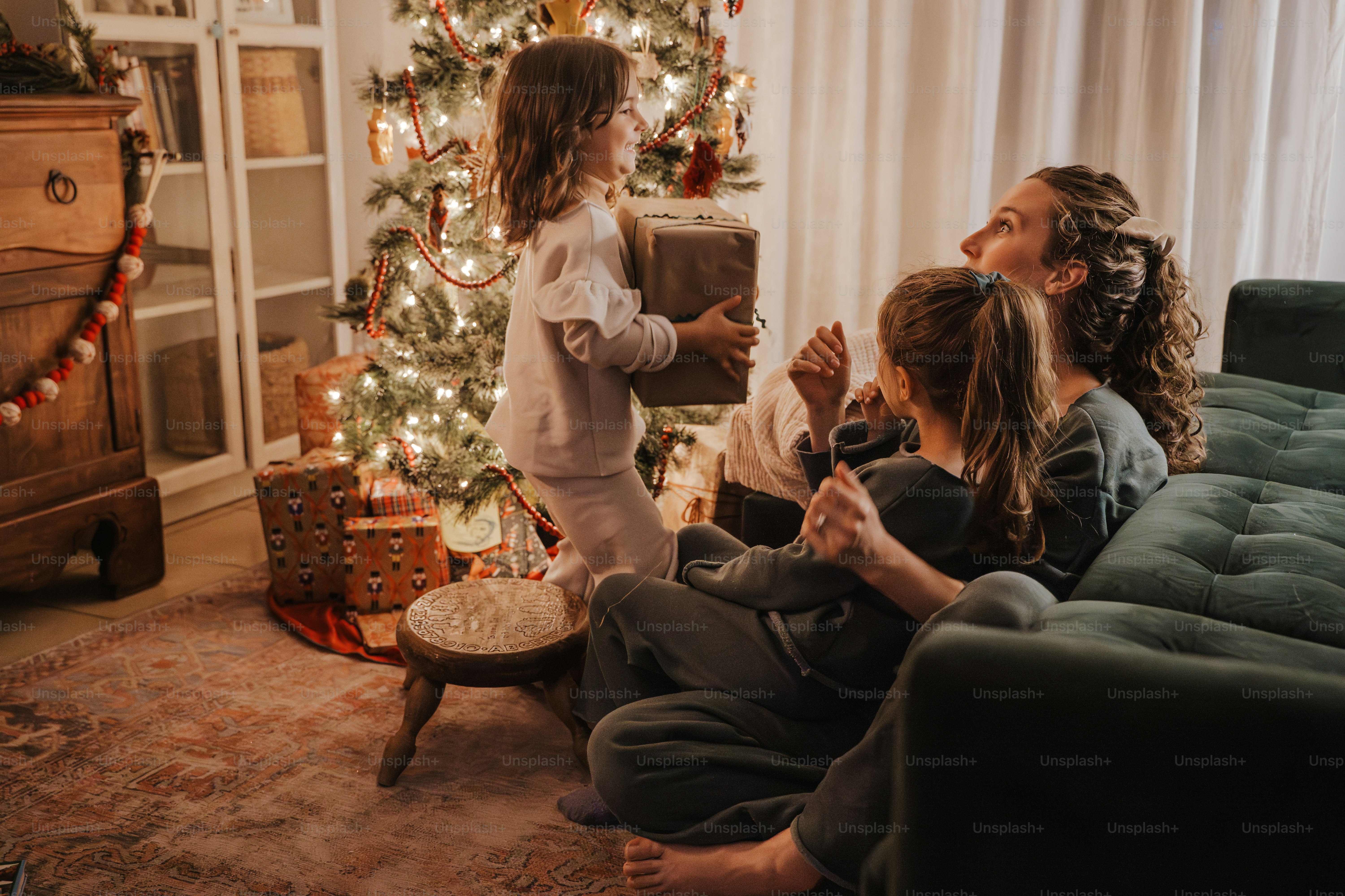 A group of children sitting around a christmas tree photo – Ensenada ...
