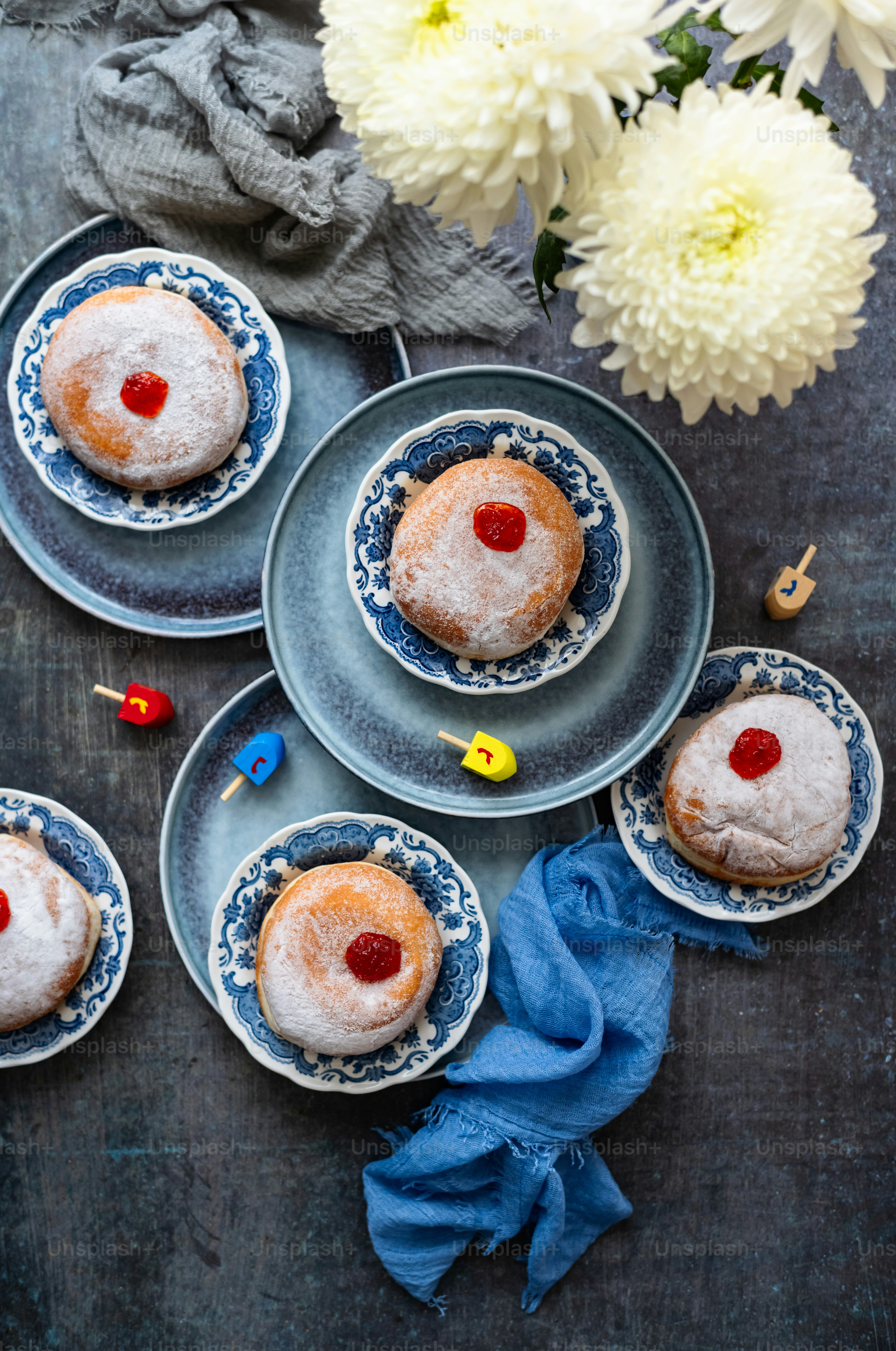 A table topped with blue plates filled with pastries photo – Hanukkah ...